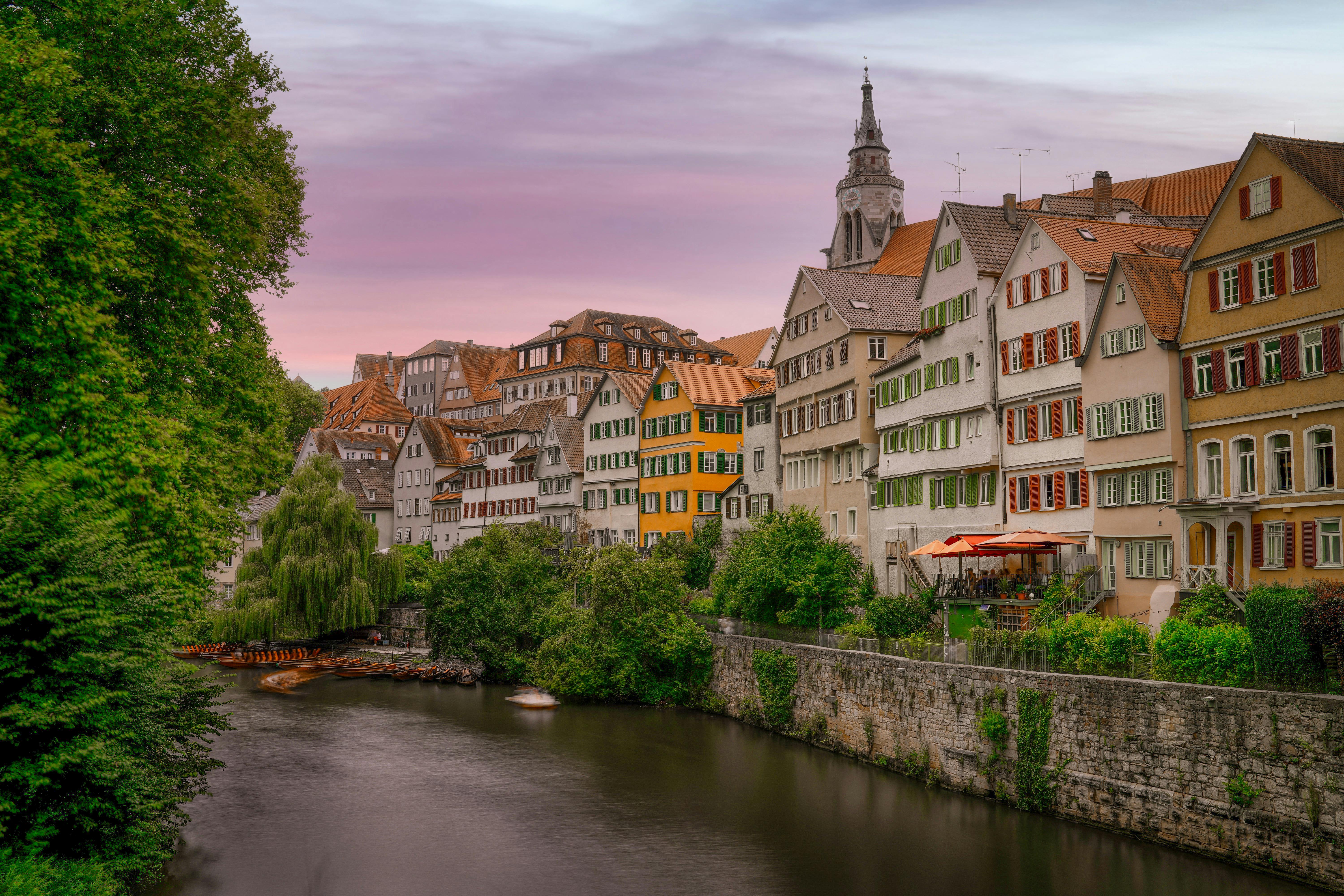 A river runs through a city with buildings on both sides · Free Stock Photo