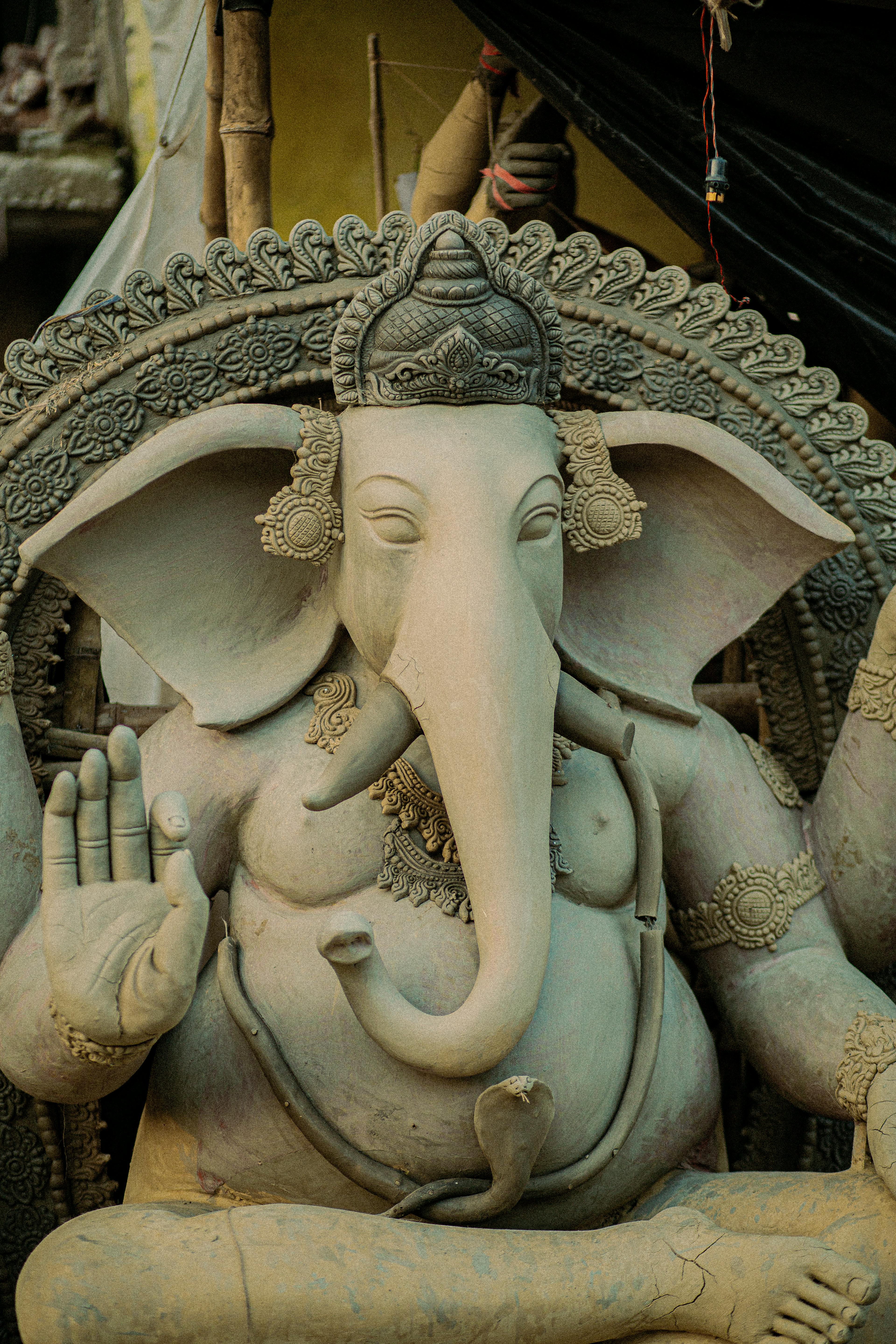 A statue of a ganesh sitting on a bench · Free Stock Photo