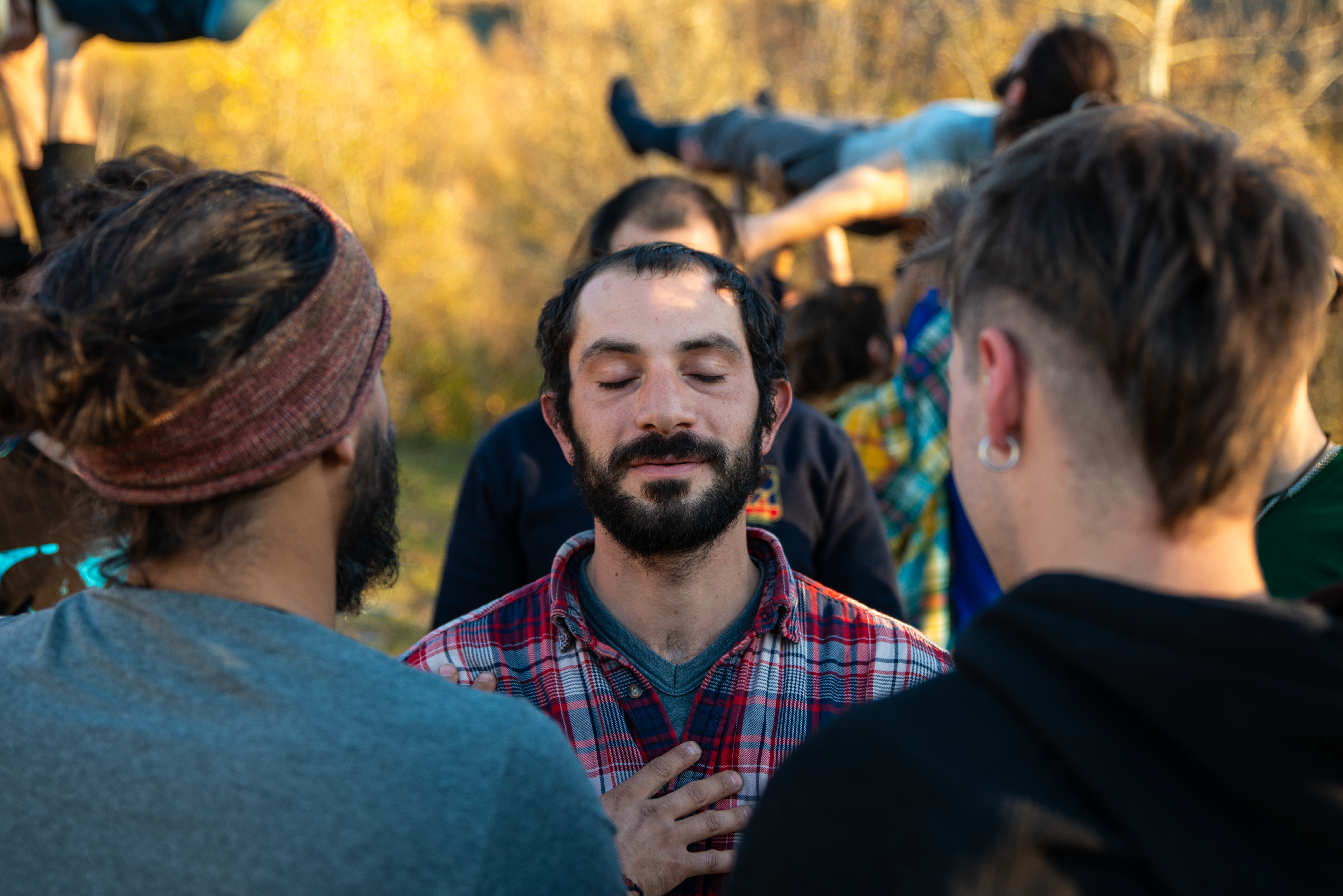 A group of people standing around each other · Free Stock Photo