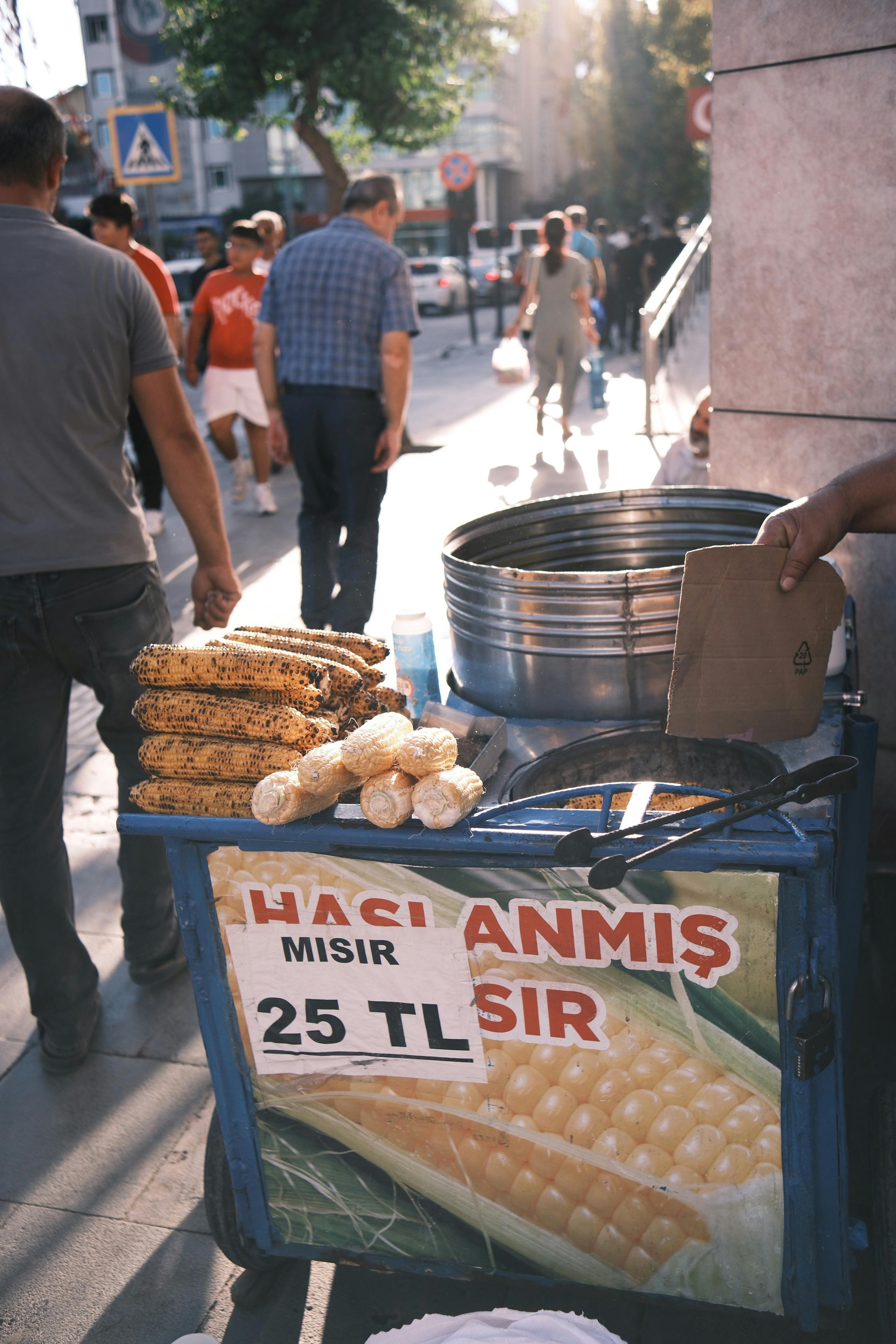 A man selling corn on a street corner · Free Stock Photo