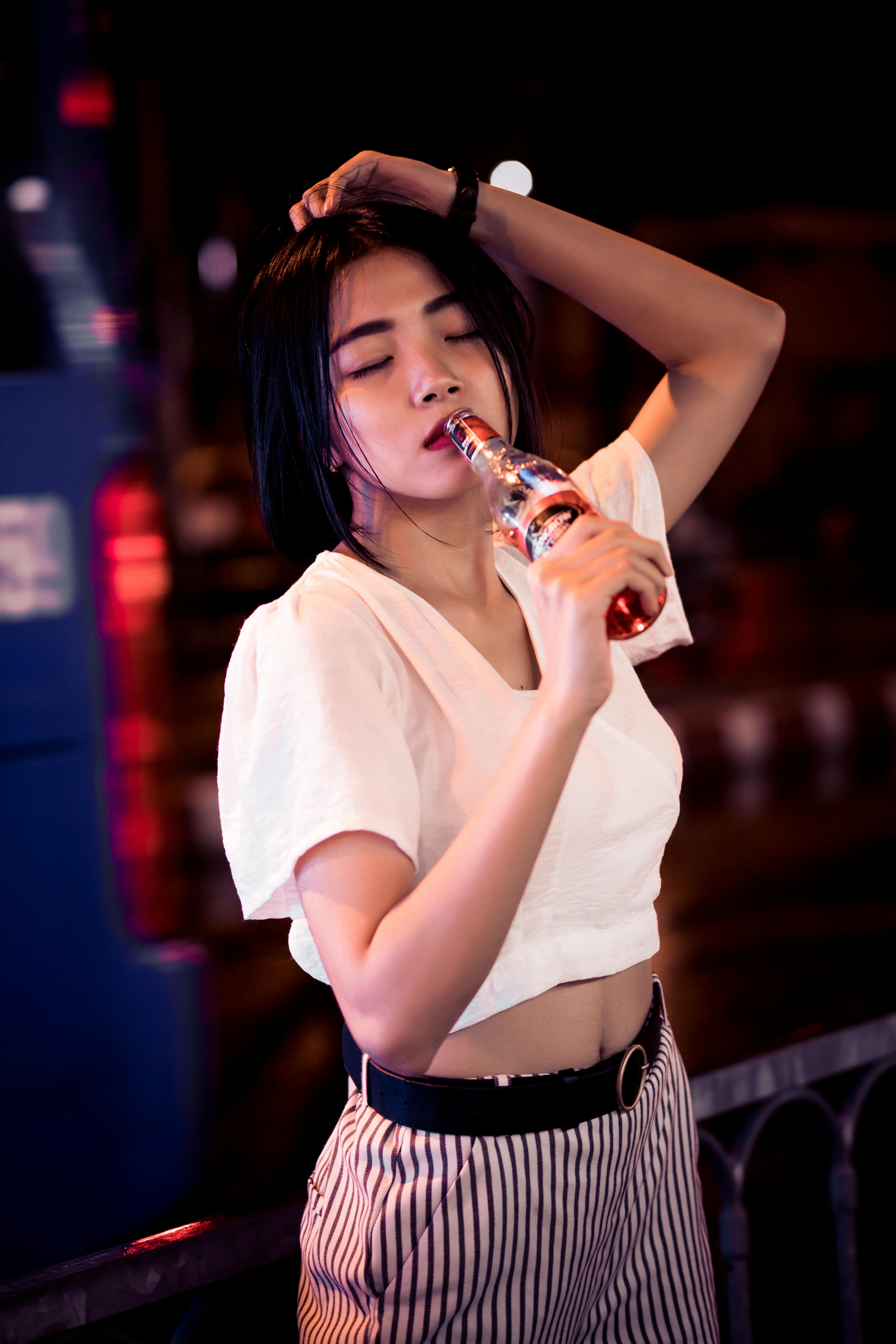 Woman Drinking from A Bottle · Free Stock Photo