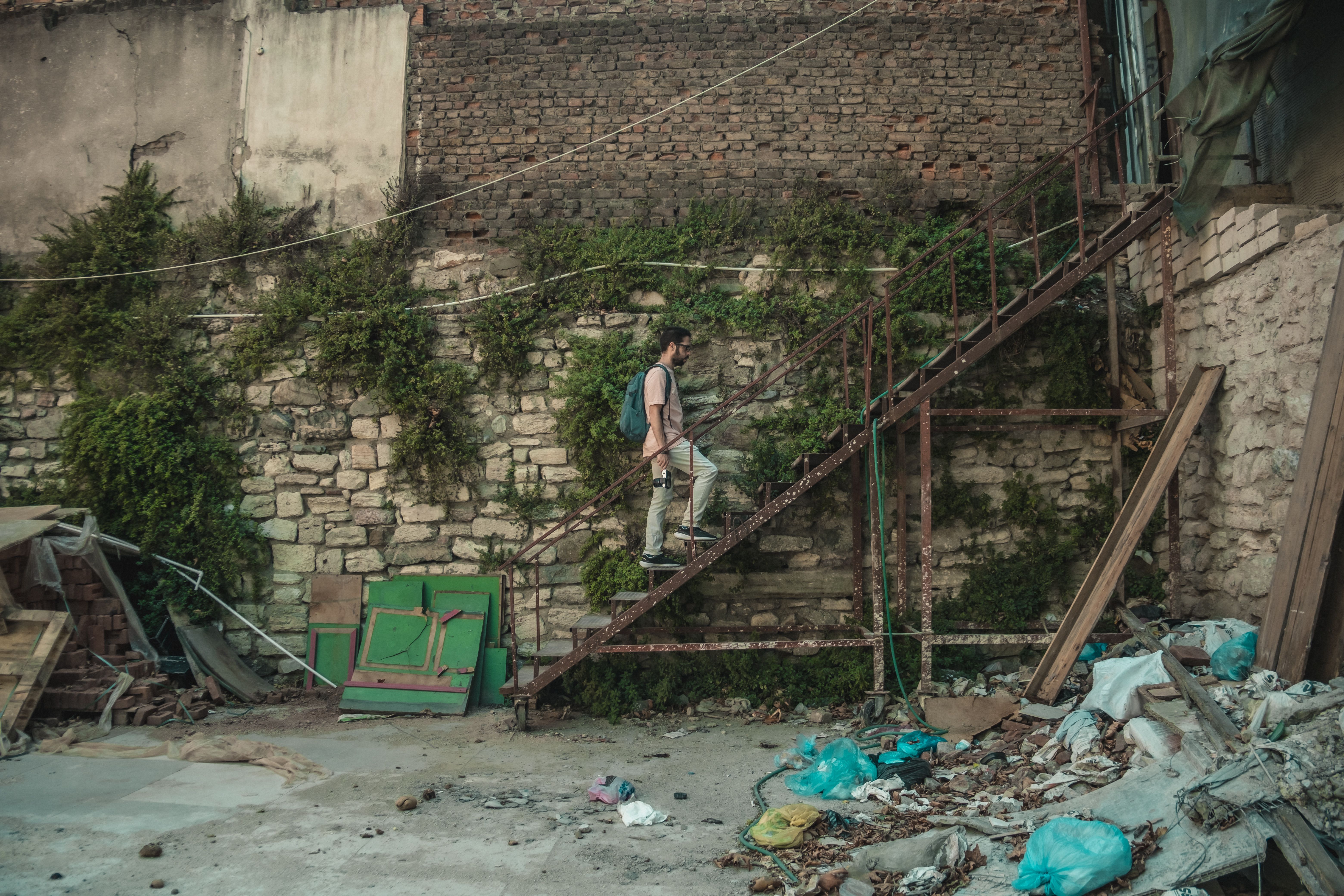 A man walking down a set of stairs in a building · Free Stock Photo