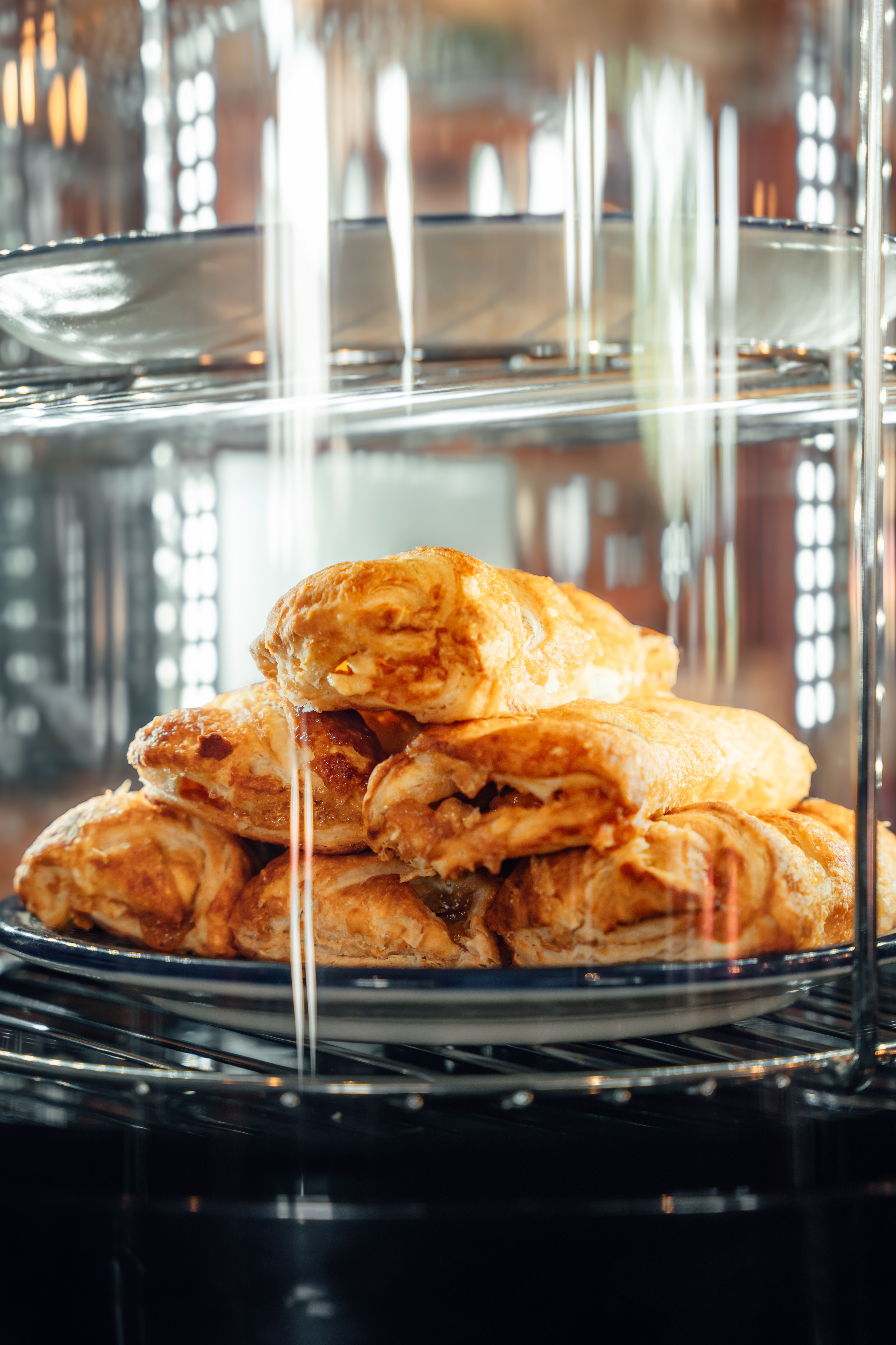 A stack of pastries in a glass case · Free Stock Photo