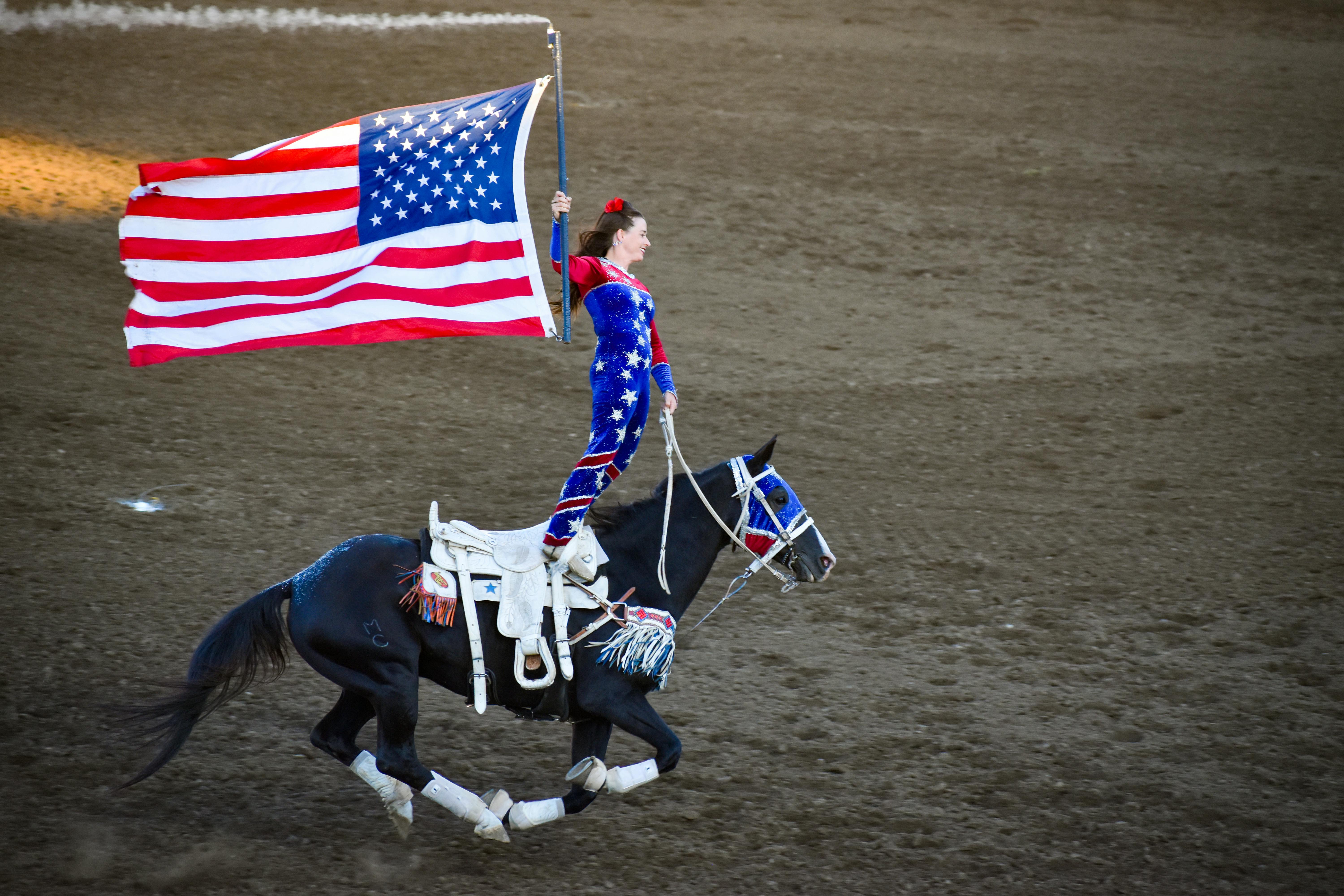 American Rodeo Rider Performing with Flag · Free Stock Photo