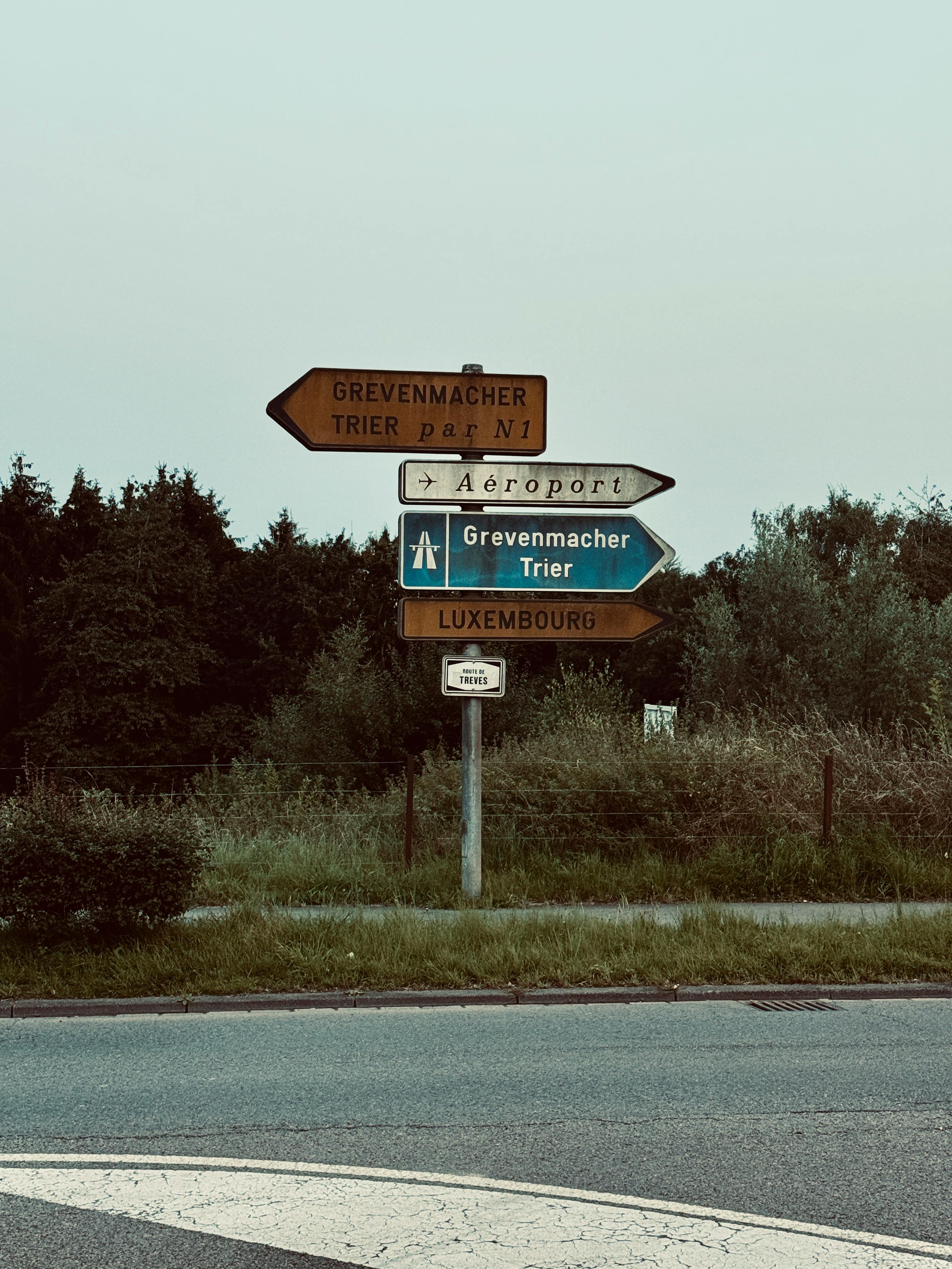 A street sign with several different directions on it · Free Stock Photo
