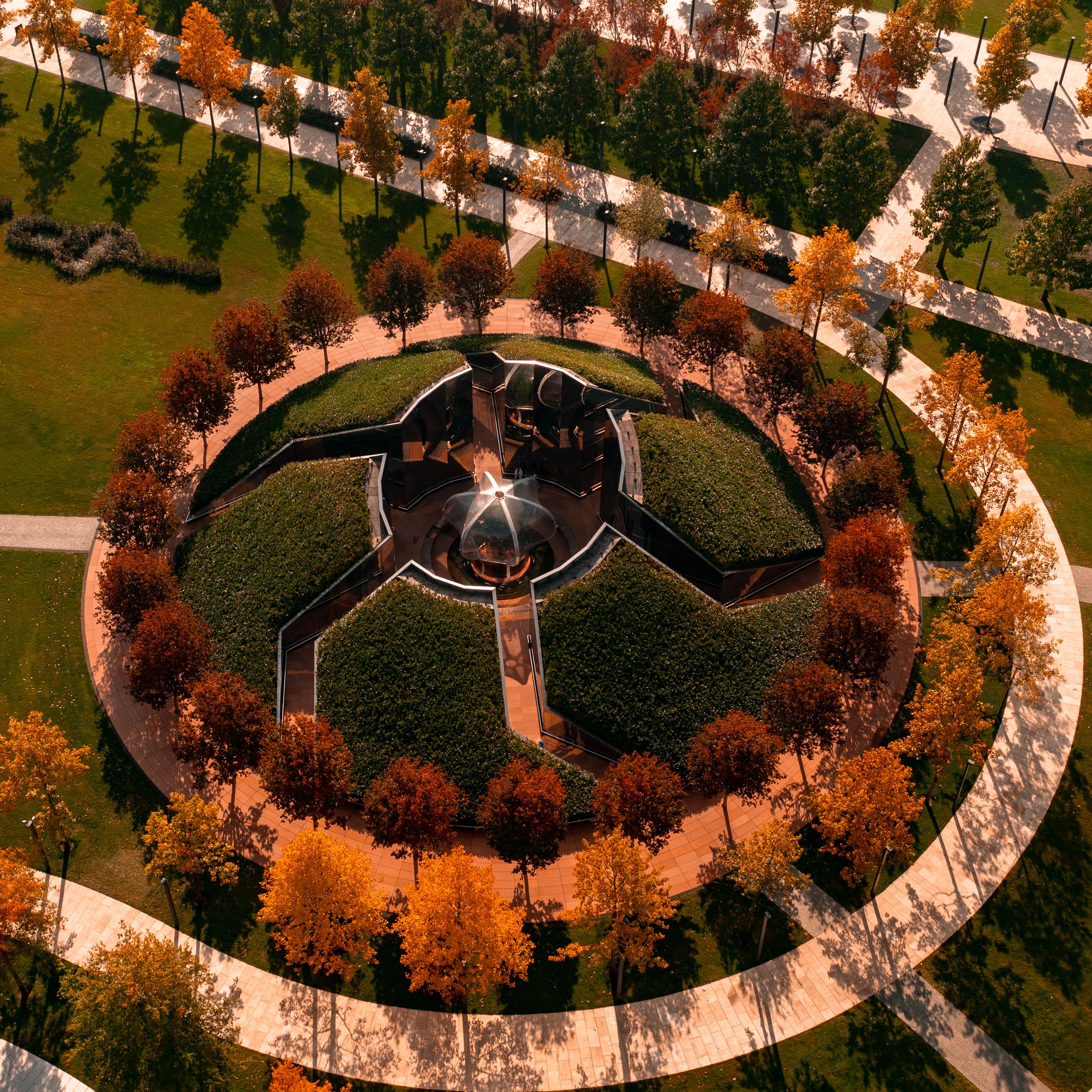 An aerial view of a circular park with trees · Free Stock Photo