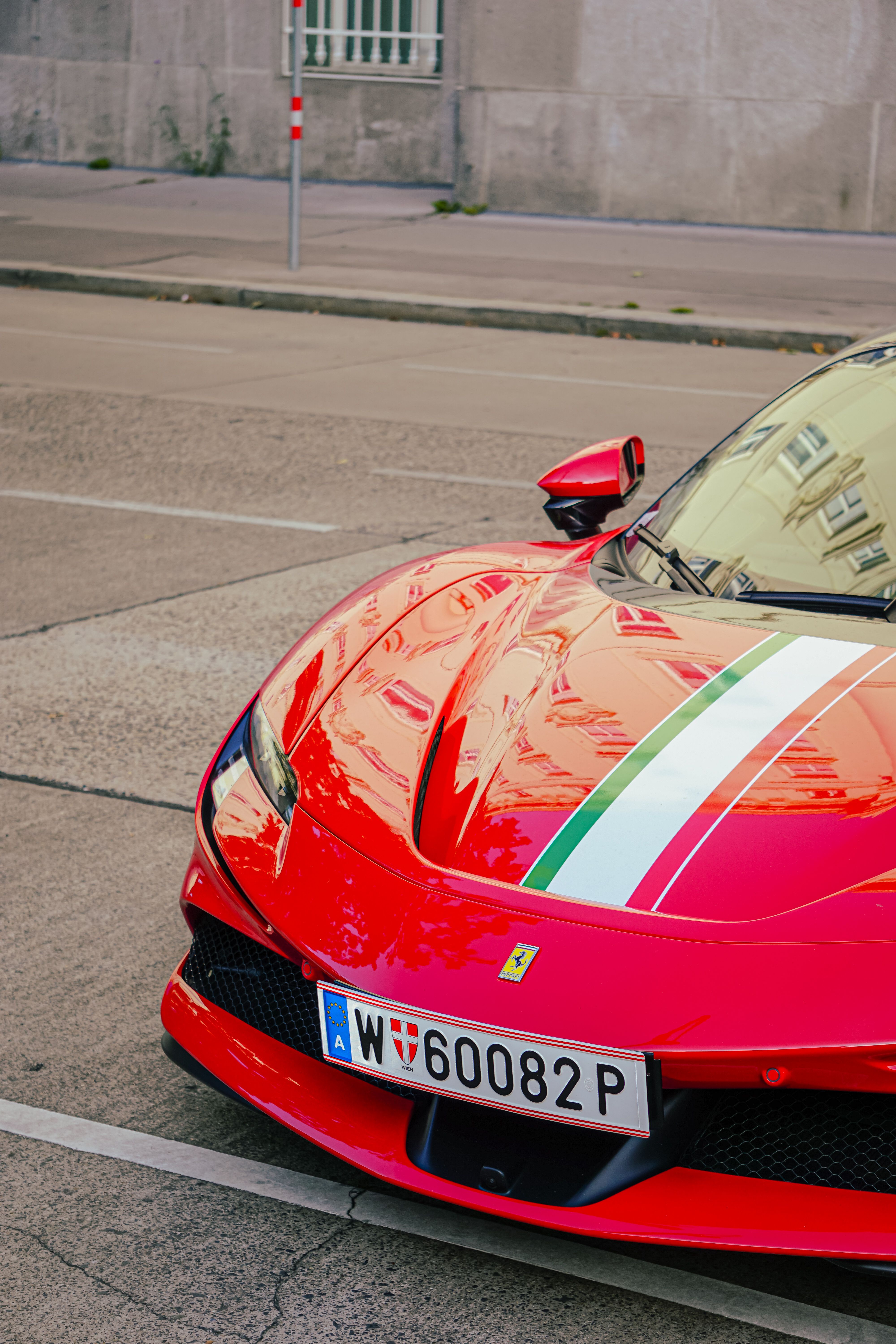 A red ferrari sports car parked in a parking lot · Free Stock Photo