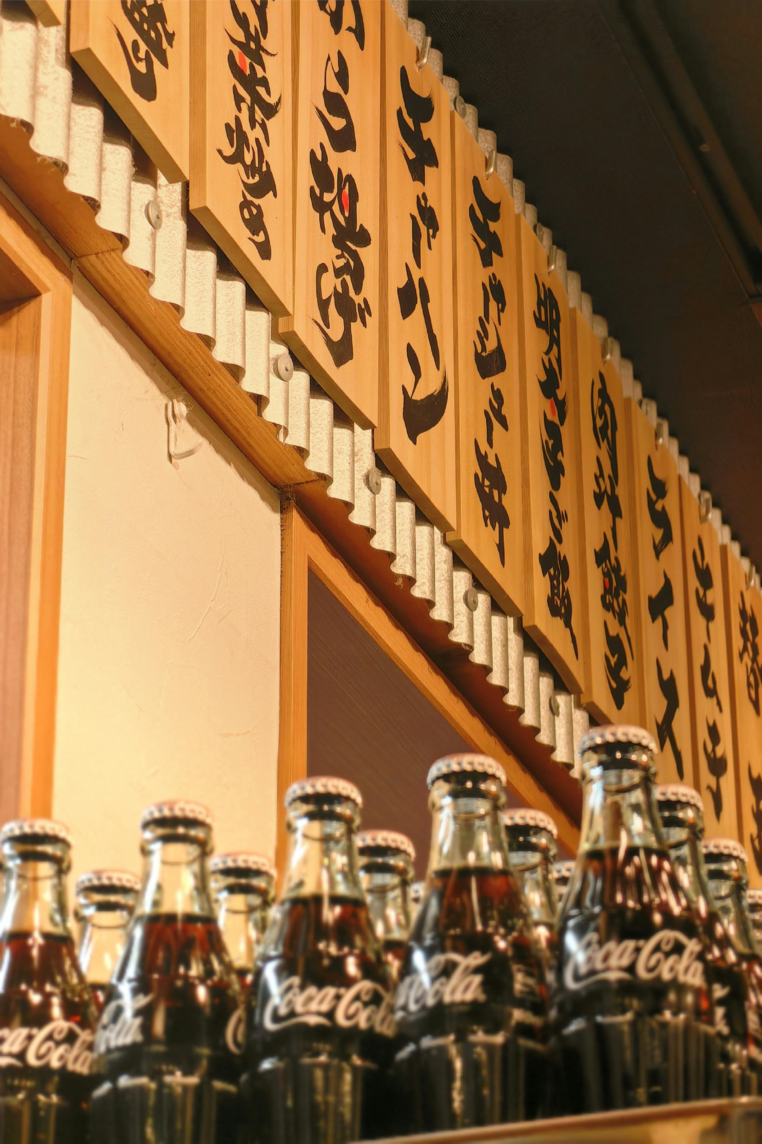 A row of coca cola bottles with japanese writing on them · Free Stock Photo