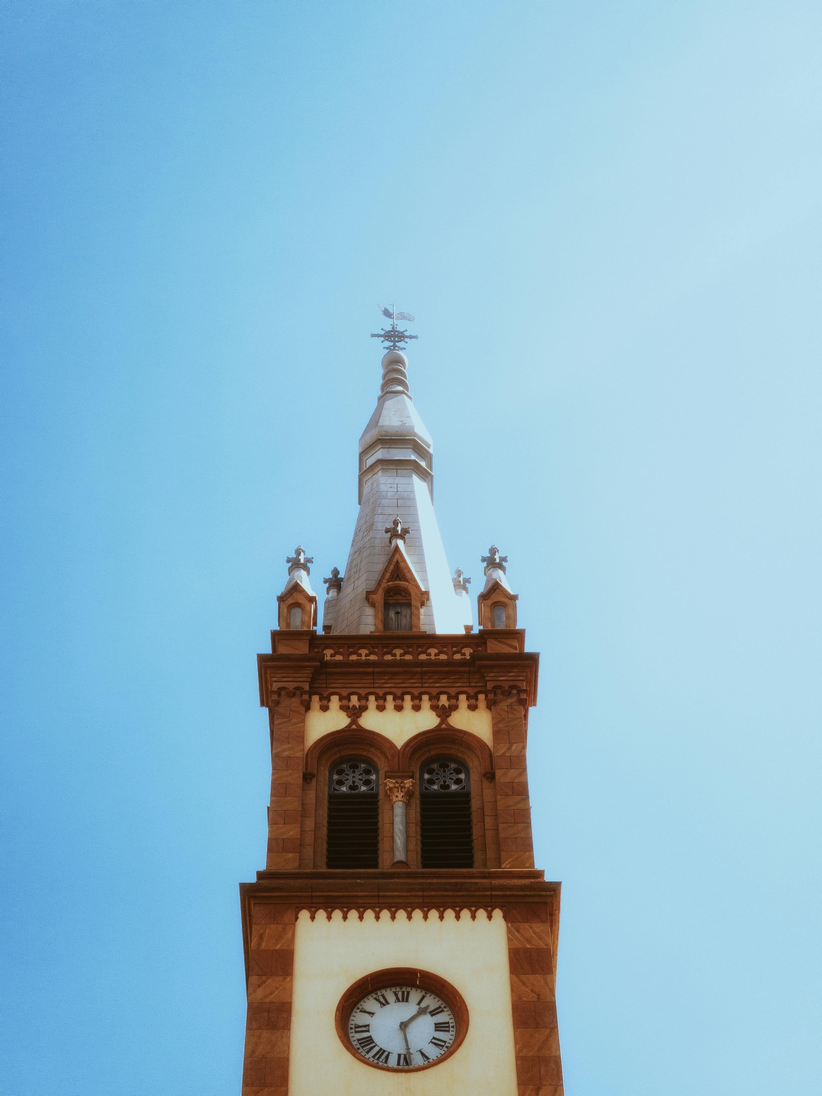 A tall church tower with a clock on it · Free Stock Photo