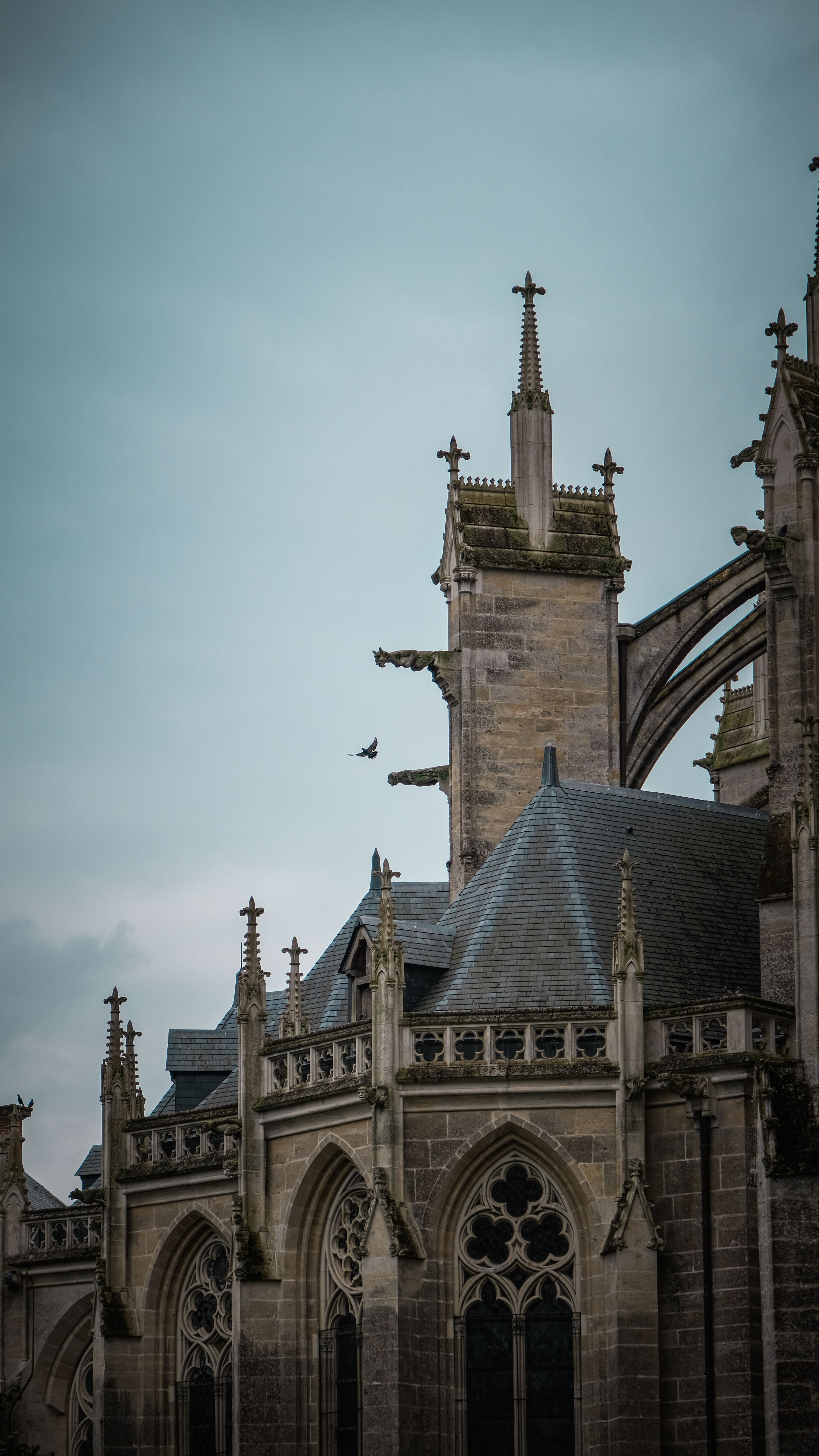 A church with spires and a clock on top · Free Stock Photo