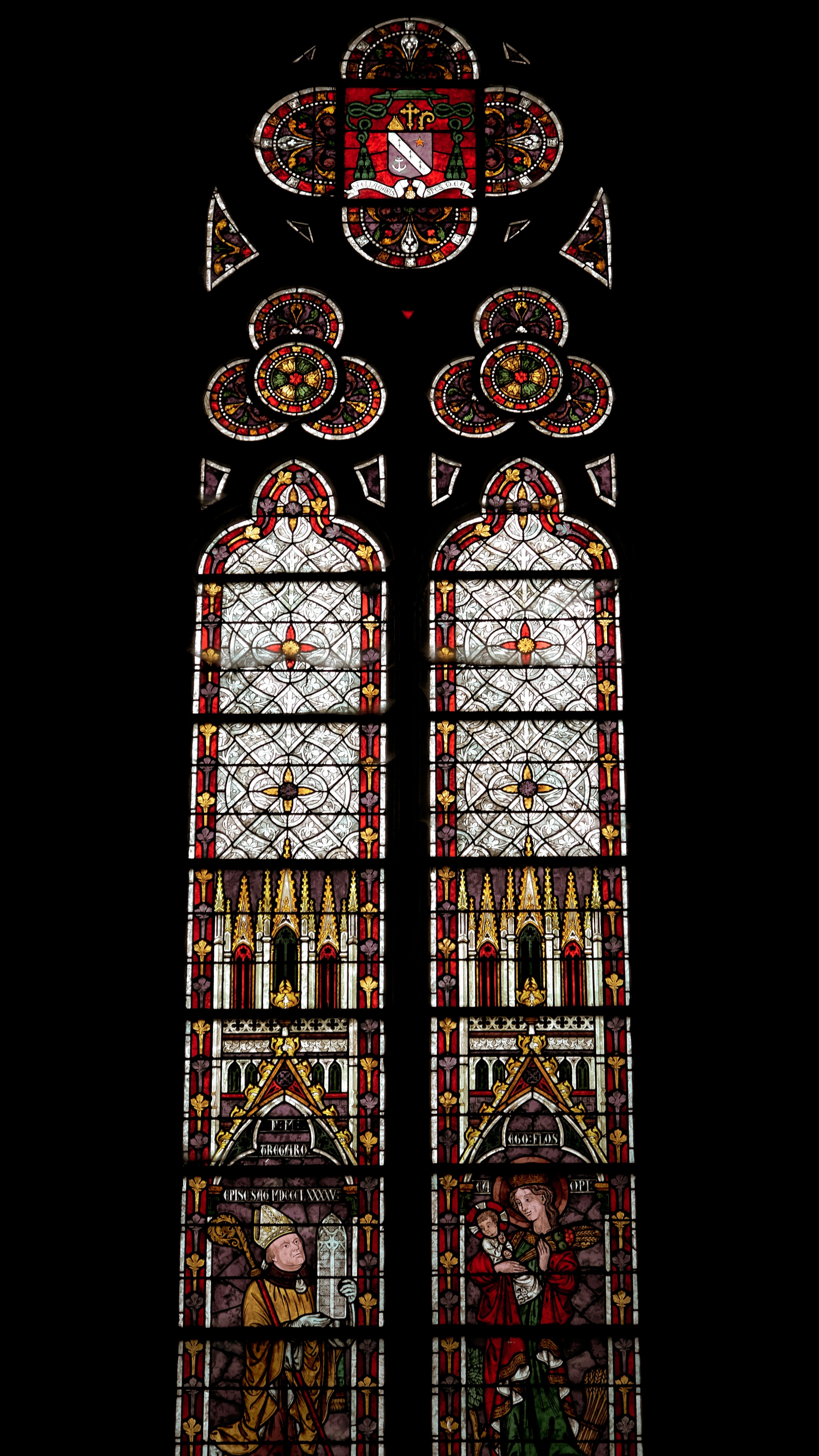 A stained glass window in a dark room · Free Stock Photo