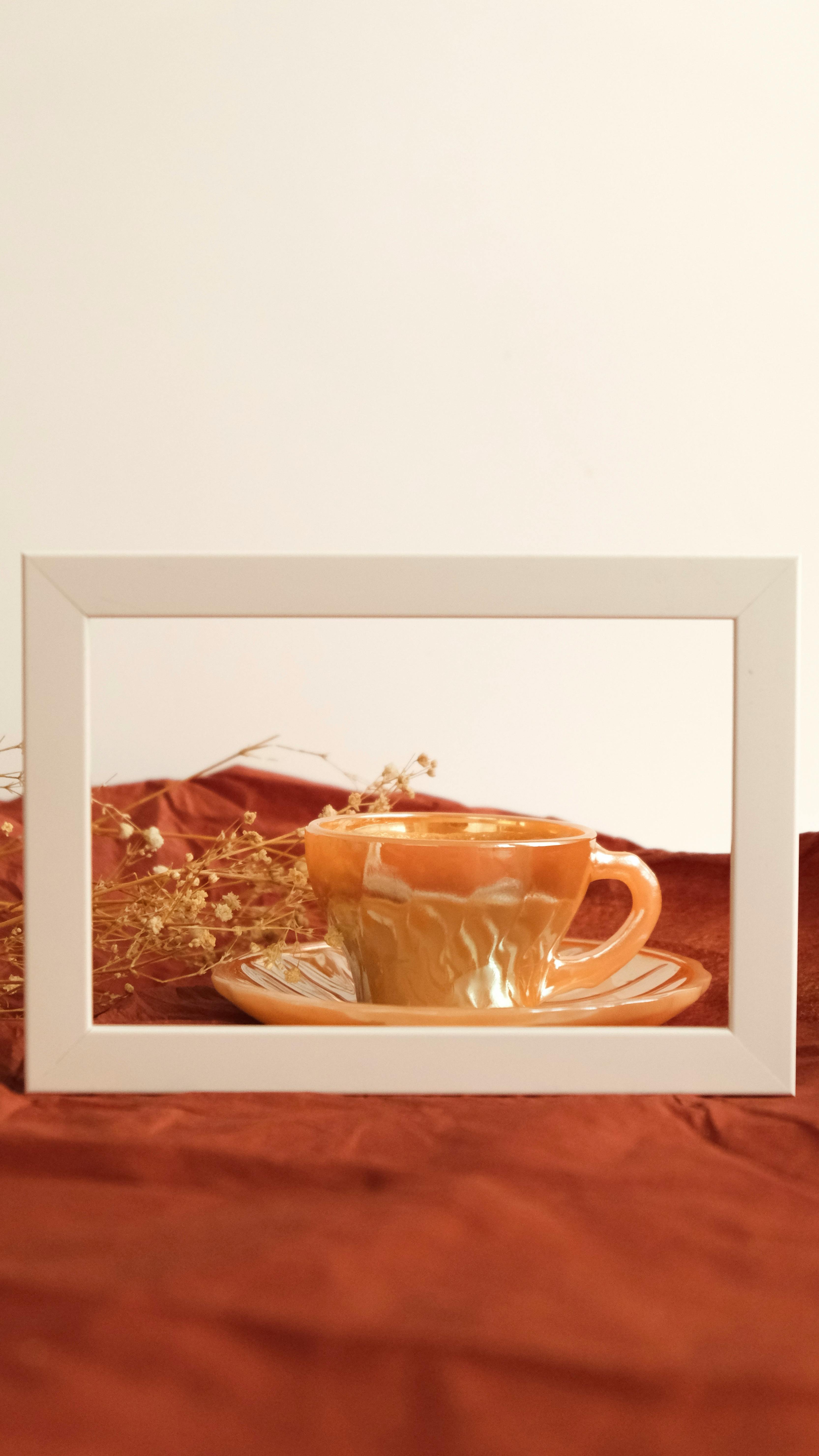 A picture frame with a cup and saucer · Free Stock Photo