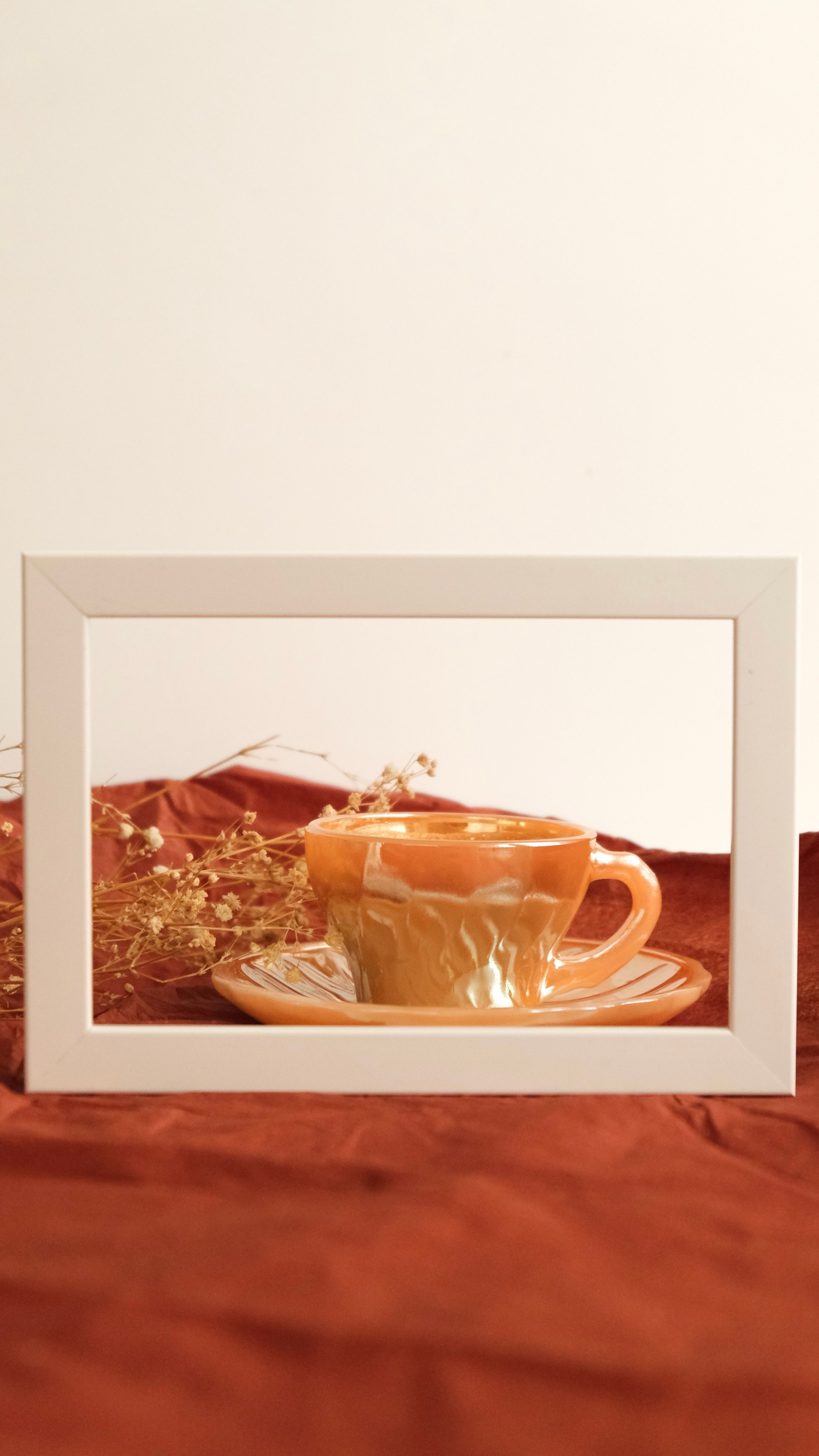 A picture frame with a cup and saucer · Free Stock Photo