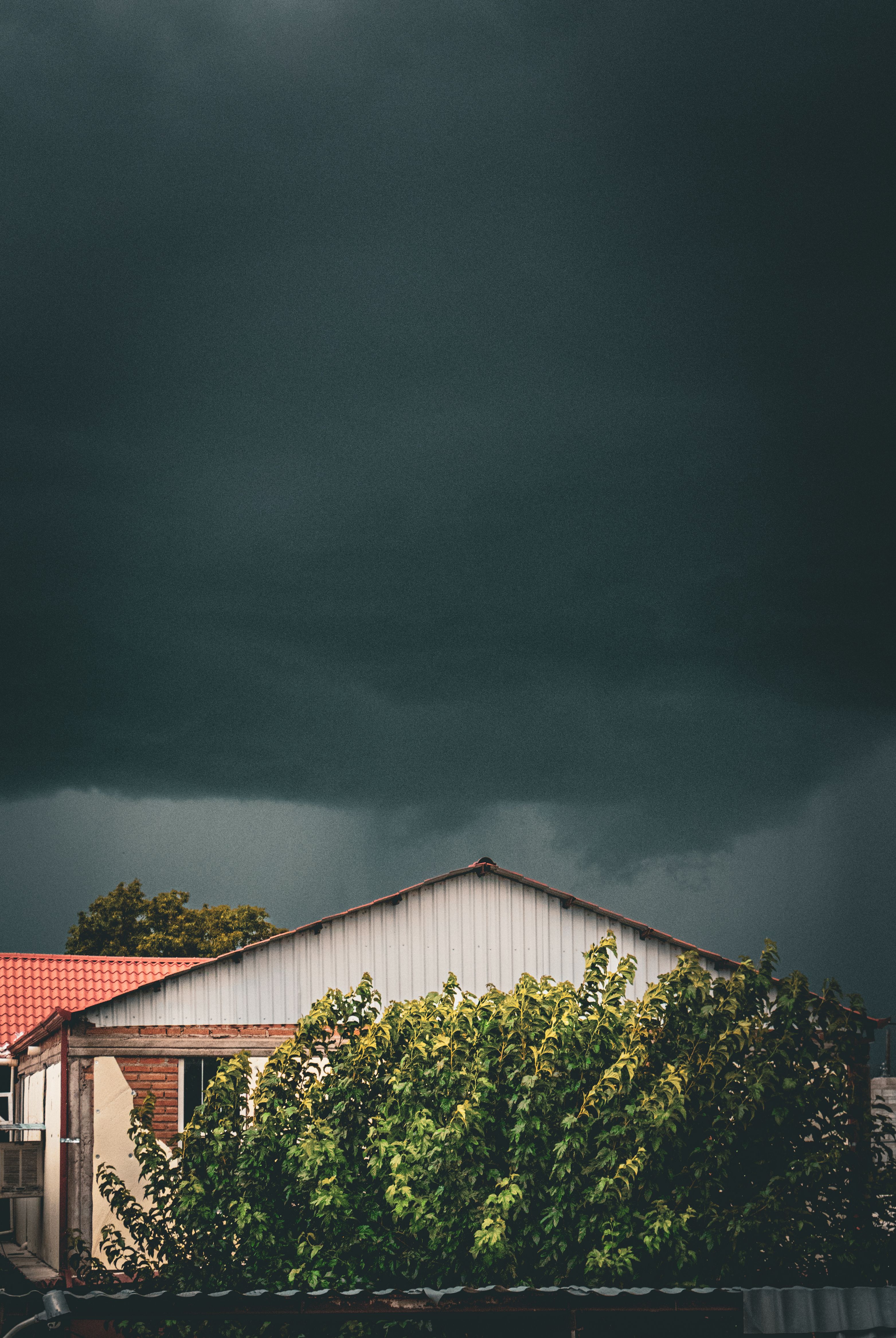 View of Dark Storm Clouds over a House · Free Stock Photo