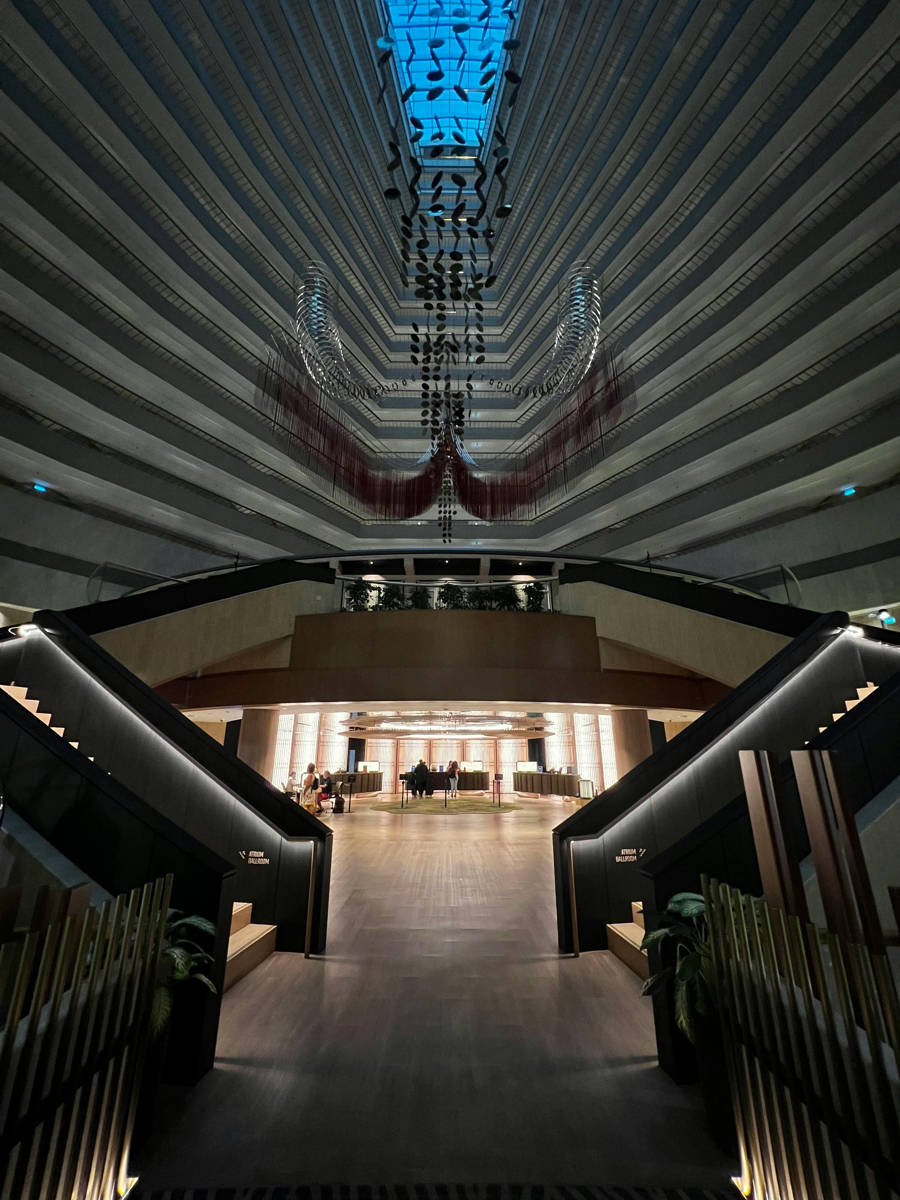The atrium of a hotel with a large chandelier · Free Stock Photo