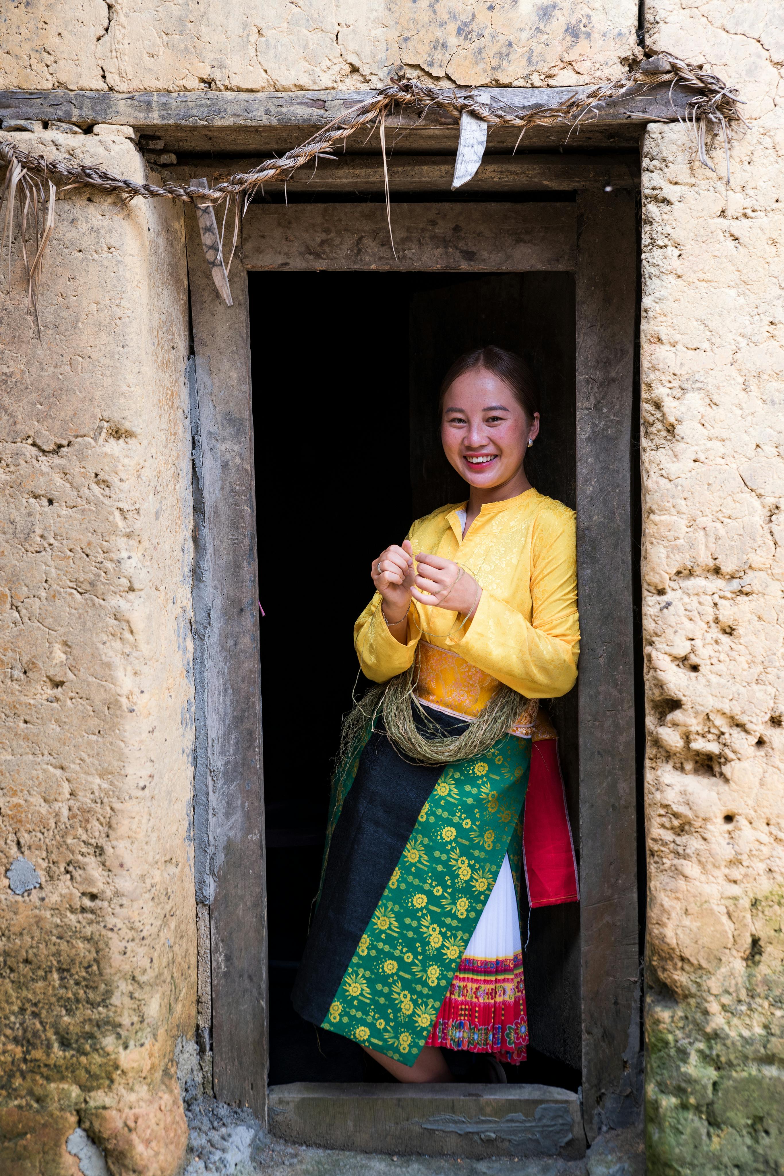 A woman in traditional clothing standing in a doorway · Free Stock Photo