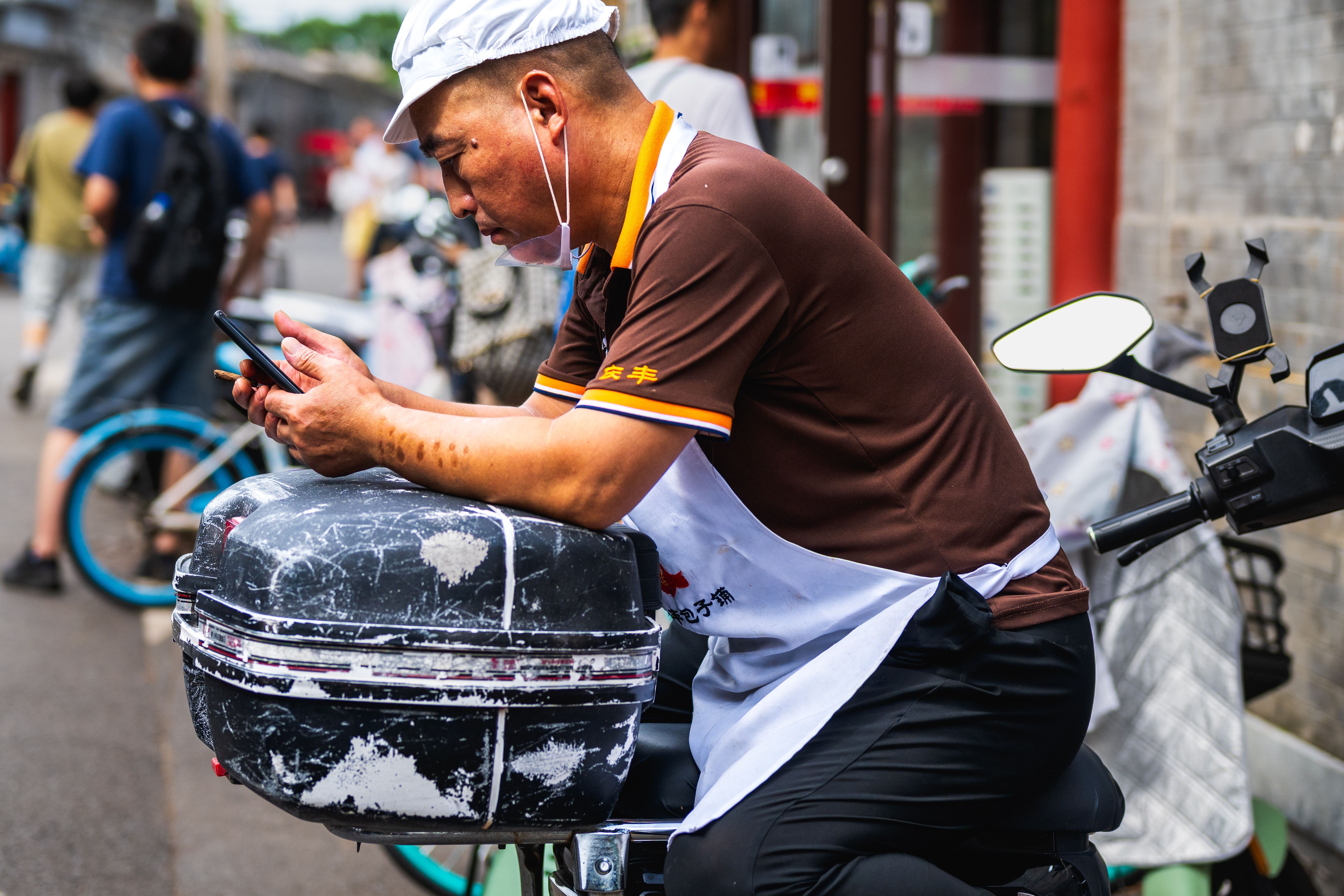 A man on a bike with a cell phone · Free Stock Photo