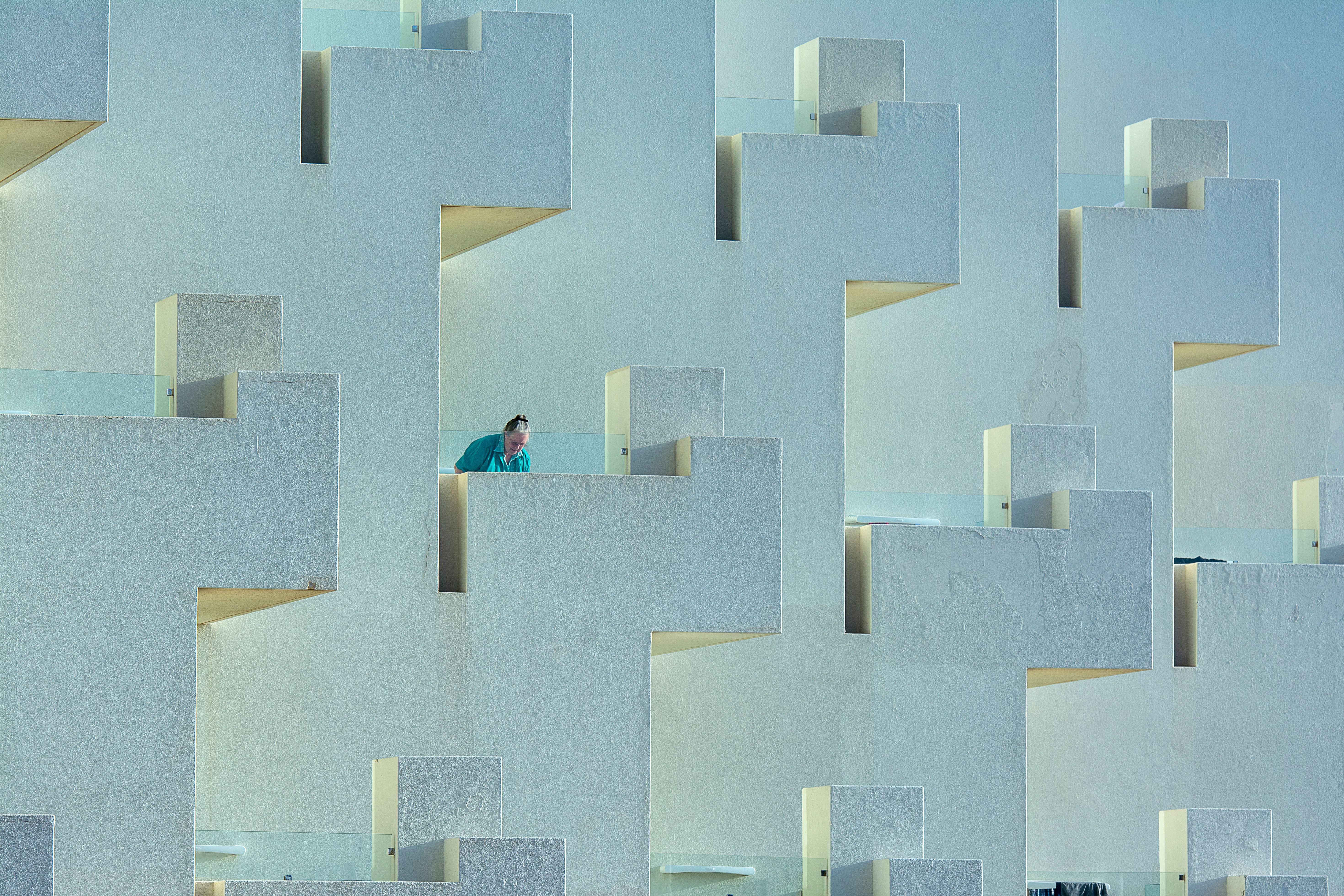 A person is sitting on top of a building · Free Stock Photo