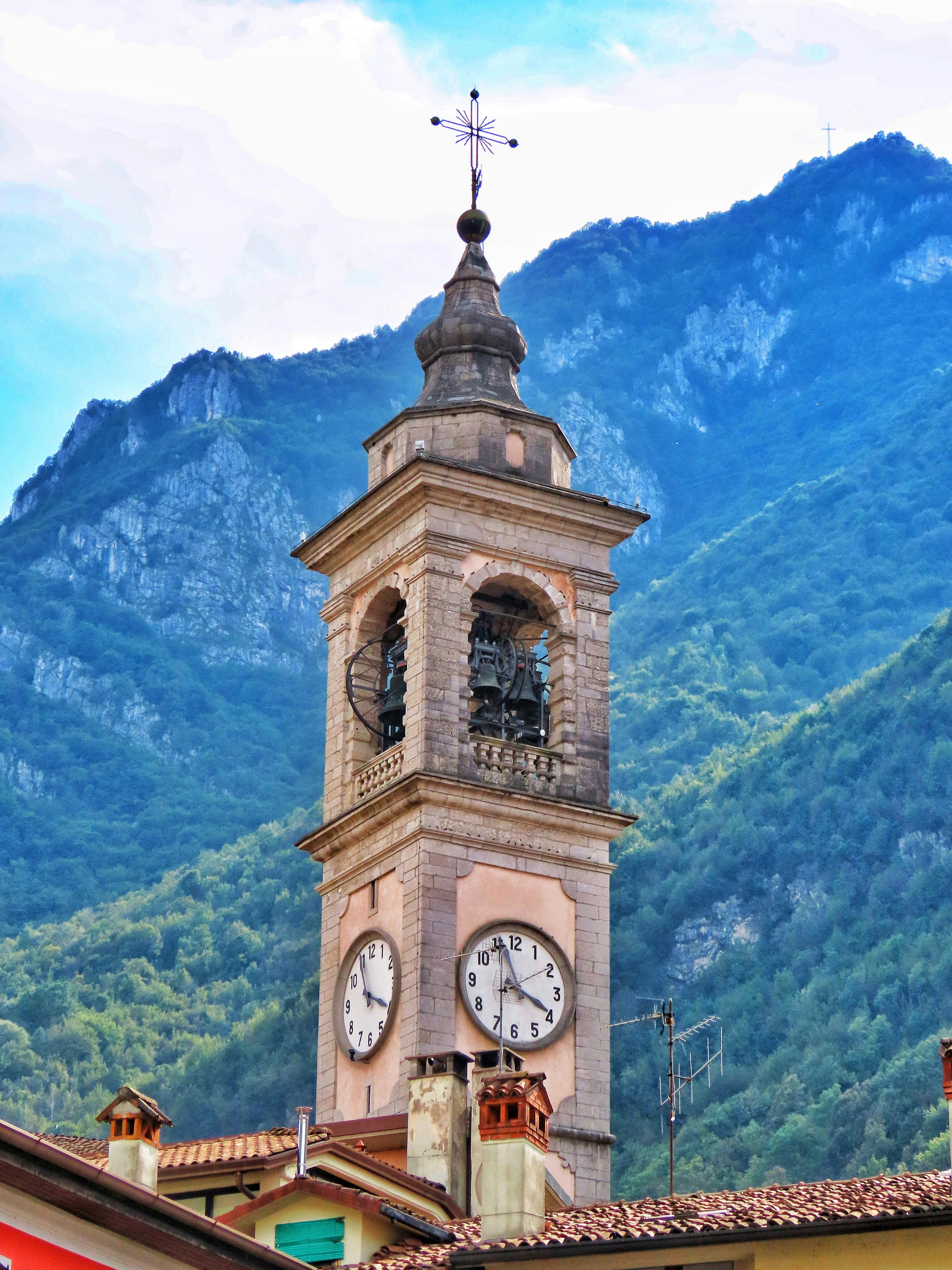 Clock Tower In Front of a Mountain · Free Stock Photo
