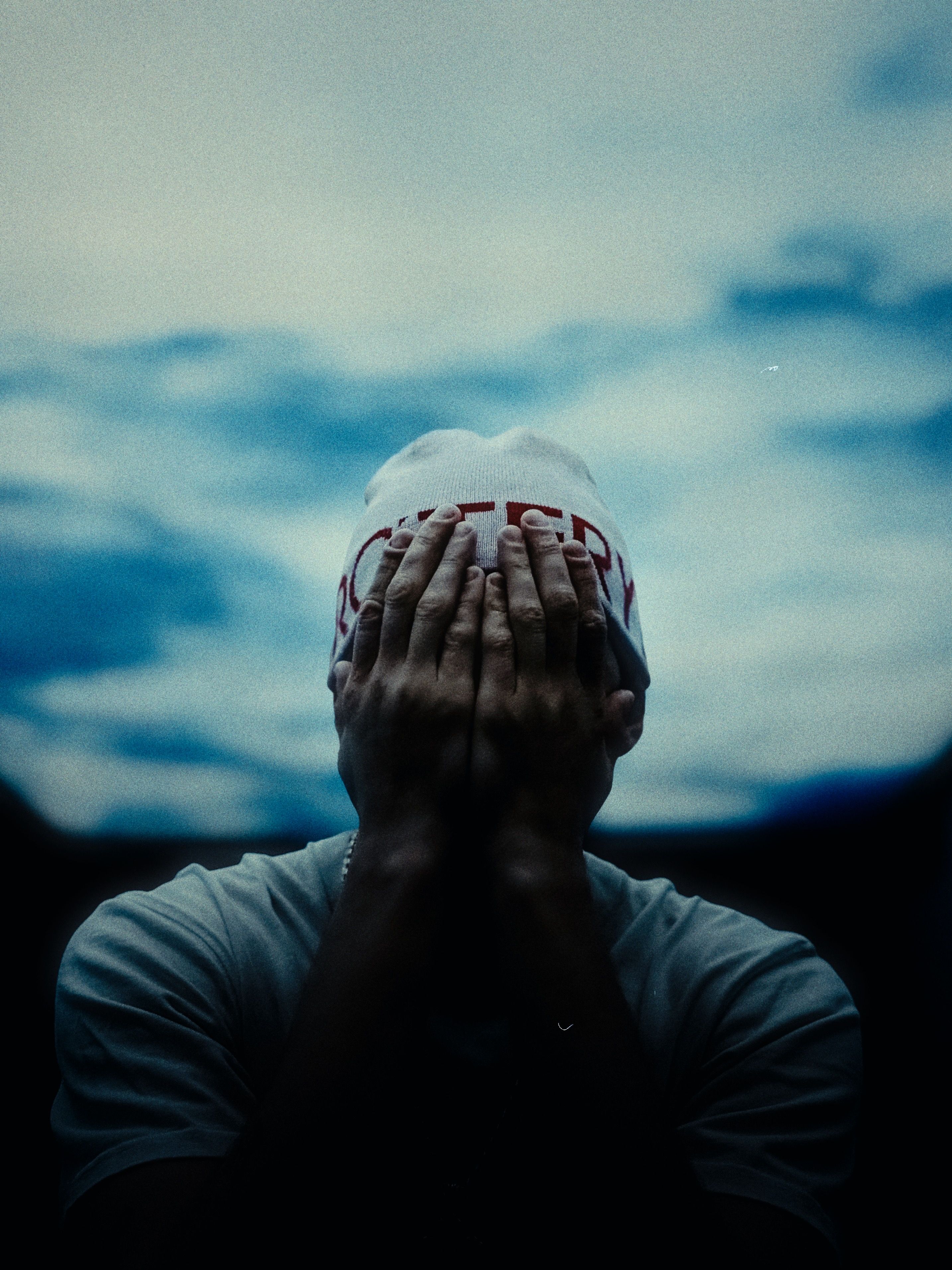 A person covering their face with their hands · Free Stock Photo