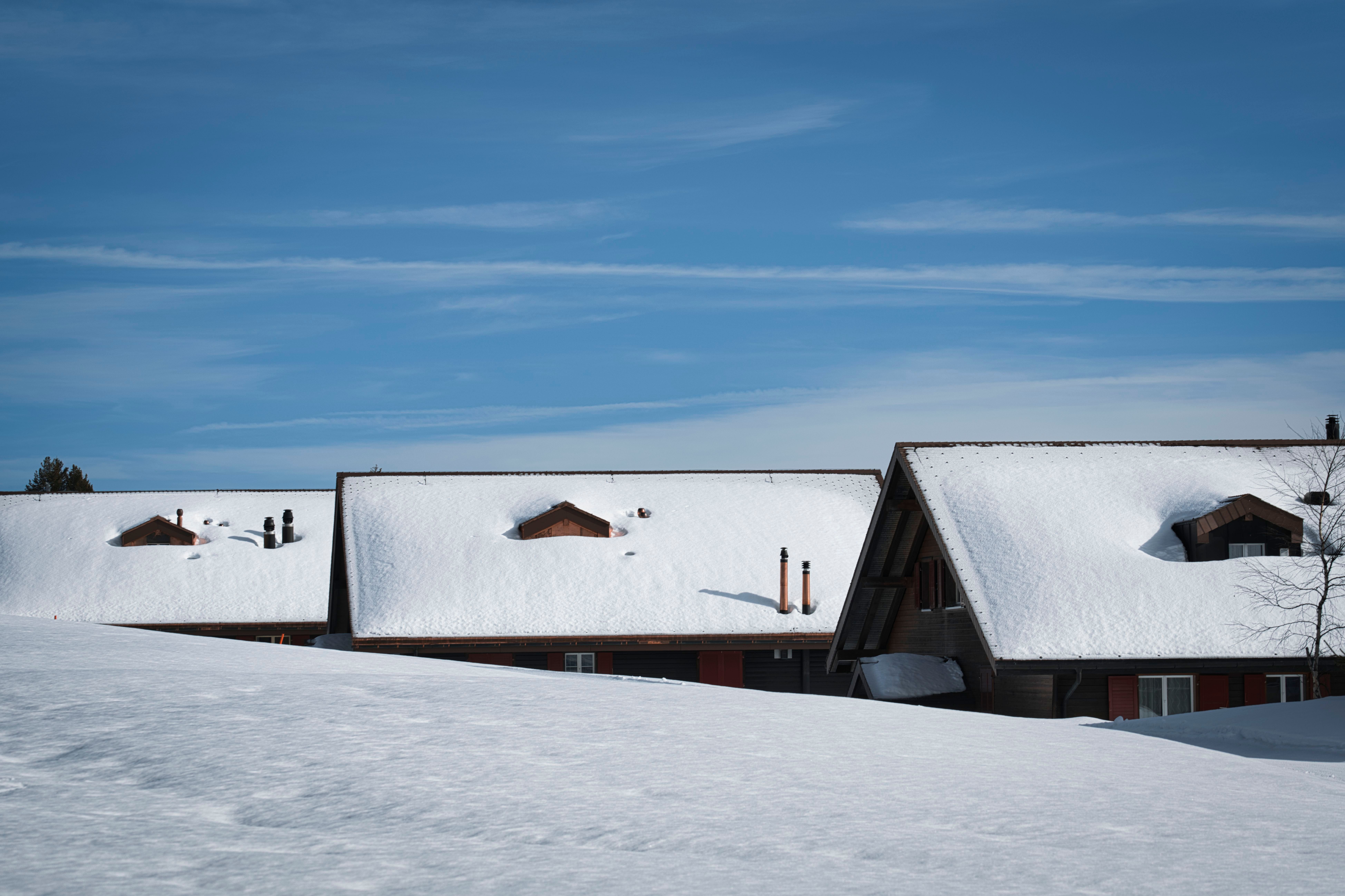 Snow-Covered Houses in Serene Winter Landscape · Free Stock Photo