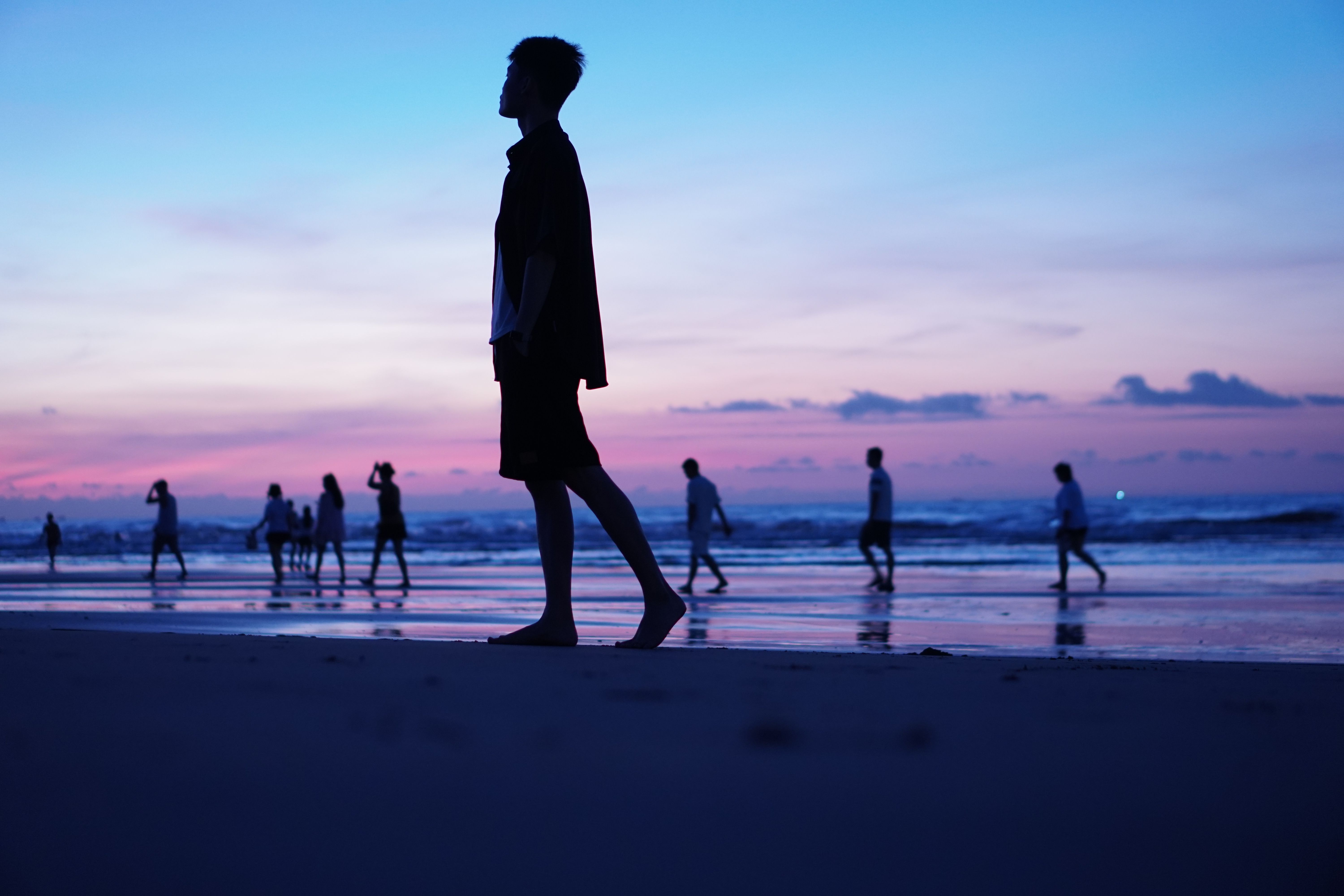 Low Angle Photo Of People Walking On The Seashore, At Dusk · Free Stock ...