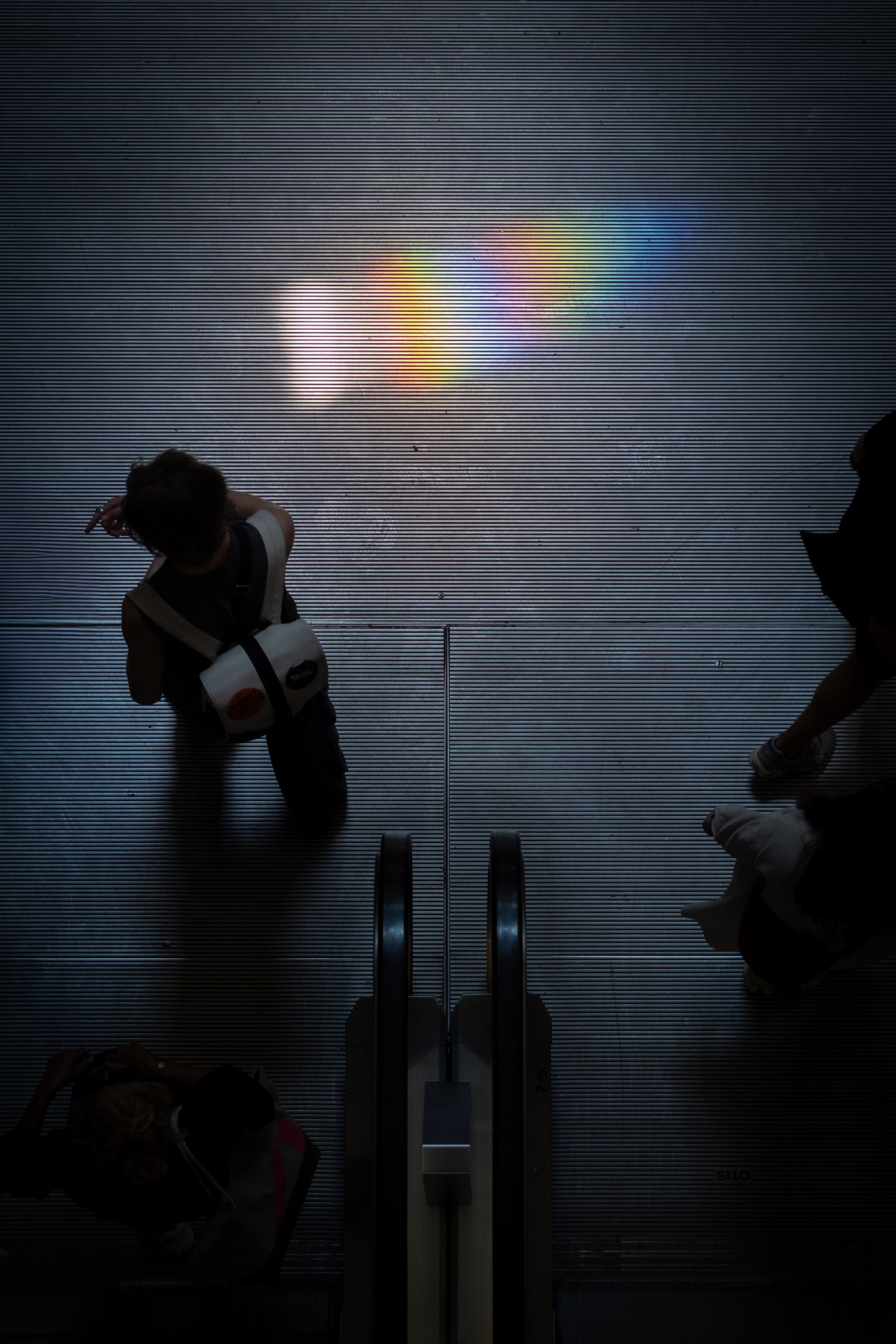 People viewed from above on escalator with rainbow light · Free Stock Photo