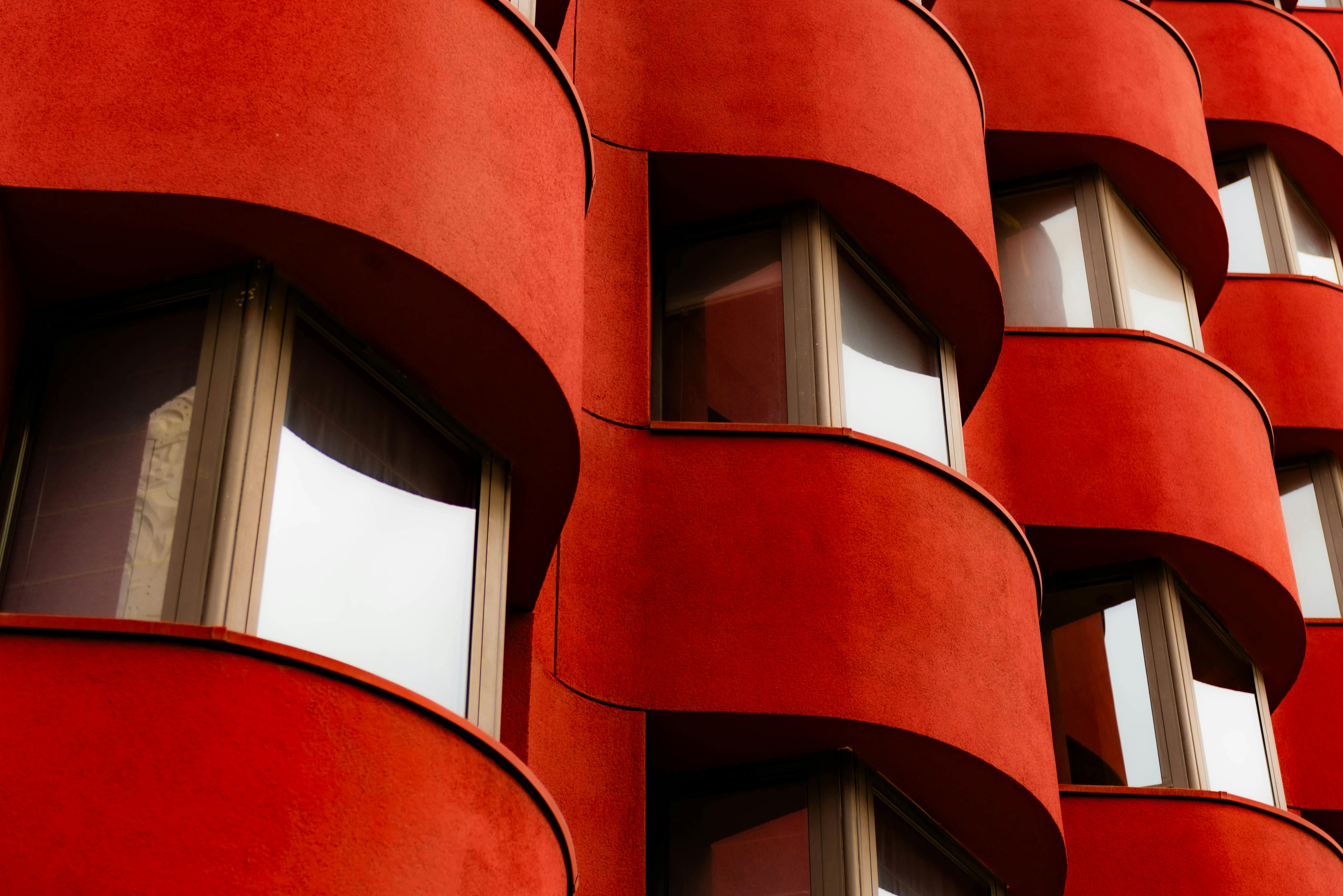 A red building with windows and a red roof · Free Stock Photo