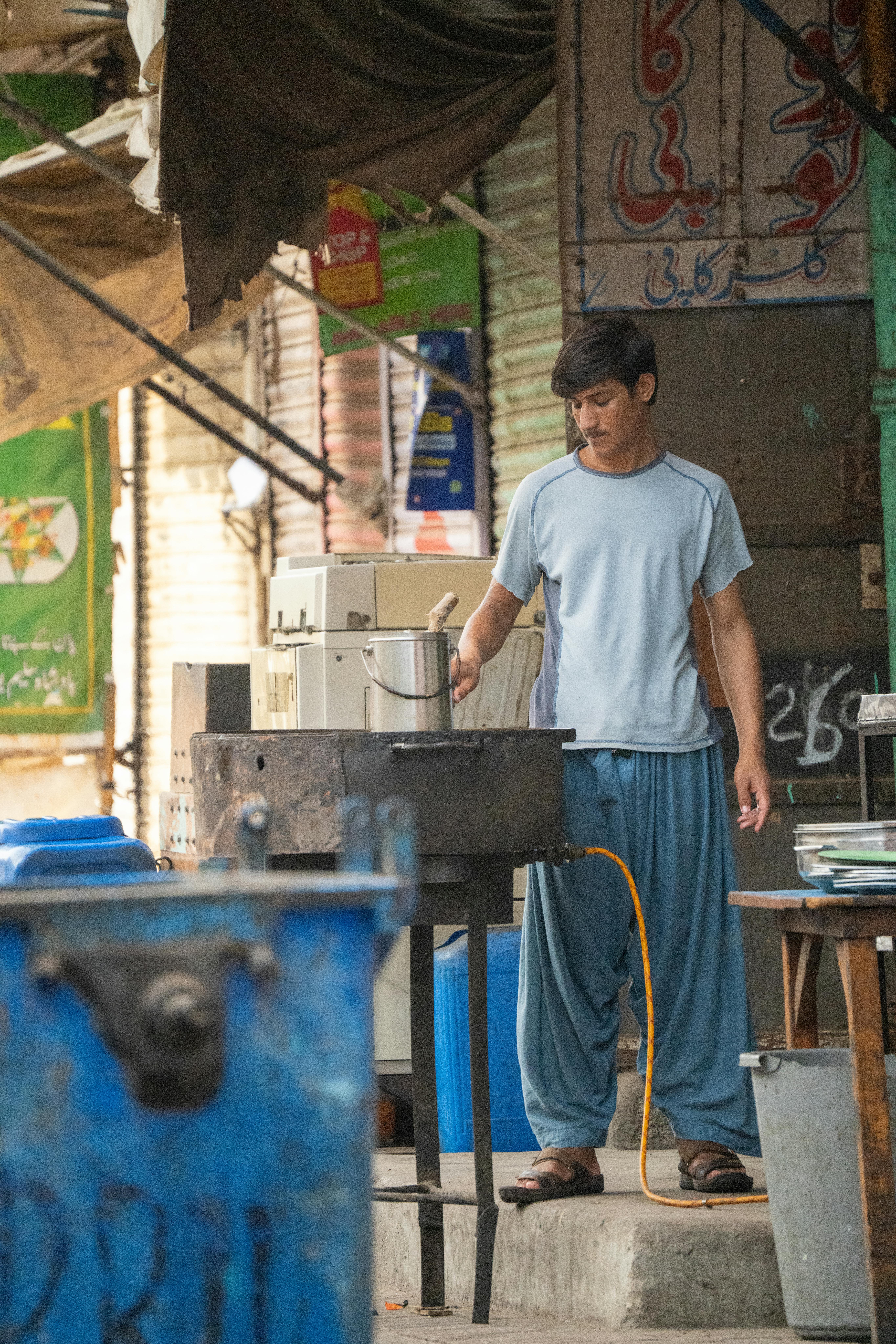 Vendor Preparing Tea at Street Stall in Karachi · Free Stock Photo