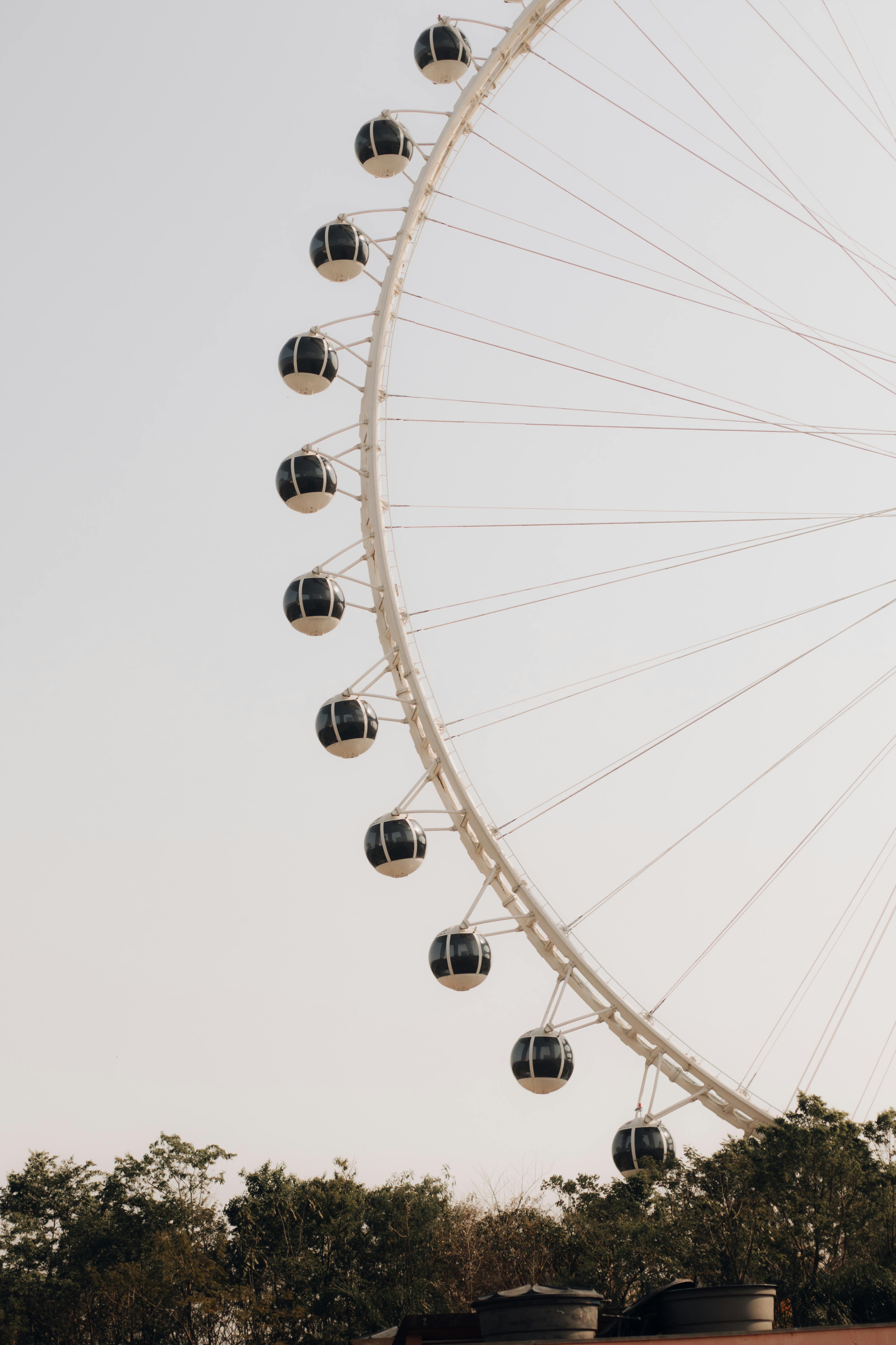 A ferris wheel is in the sky with a white background · Free Stock Photo