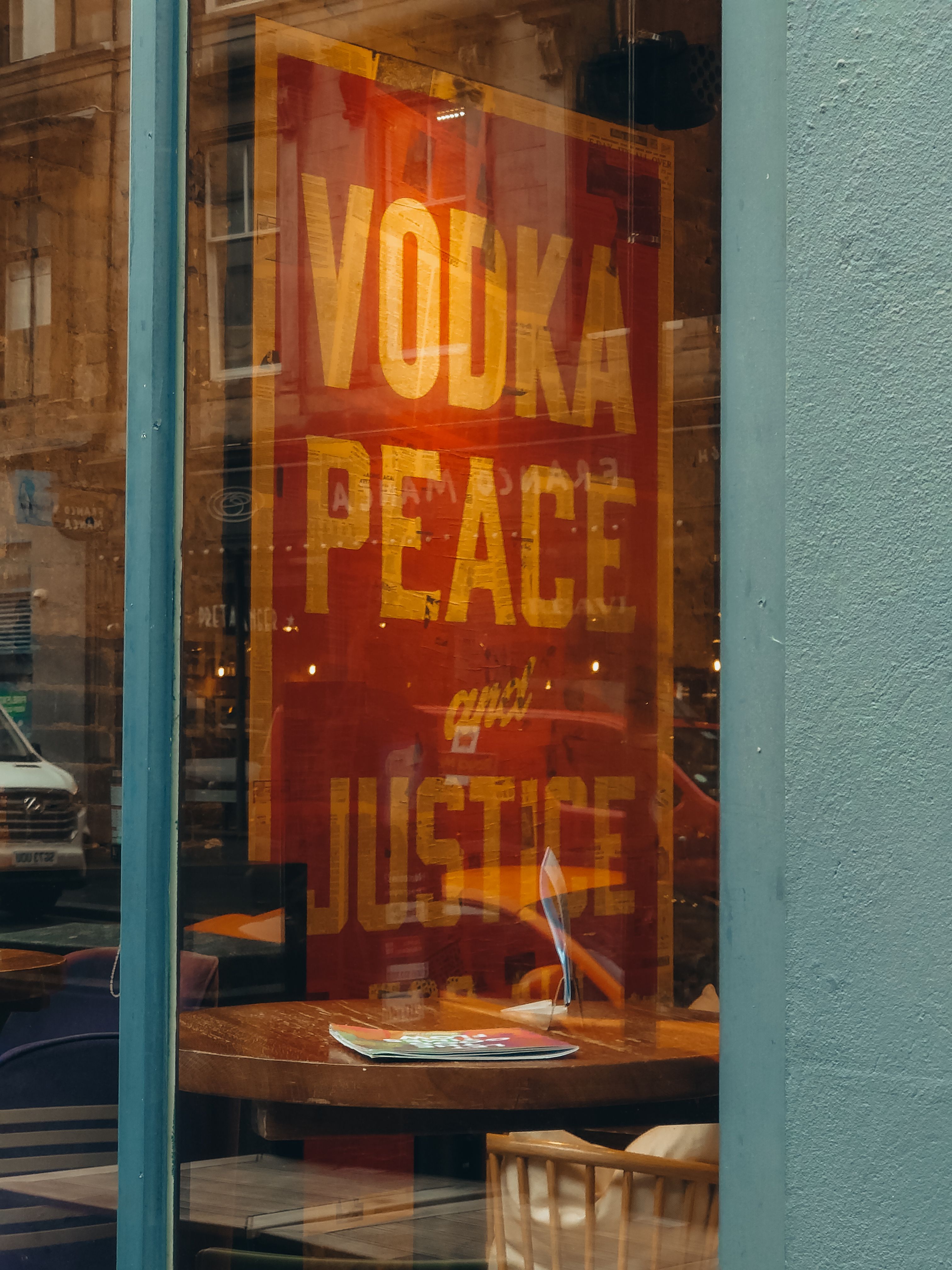 A sign that says vodka peace justice in a window · Free Stock Photo