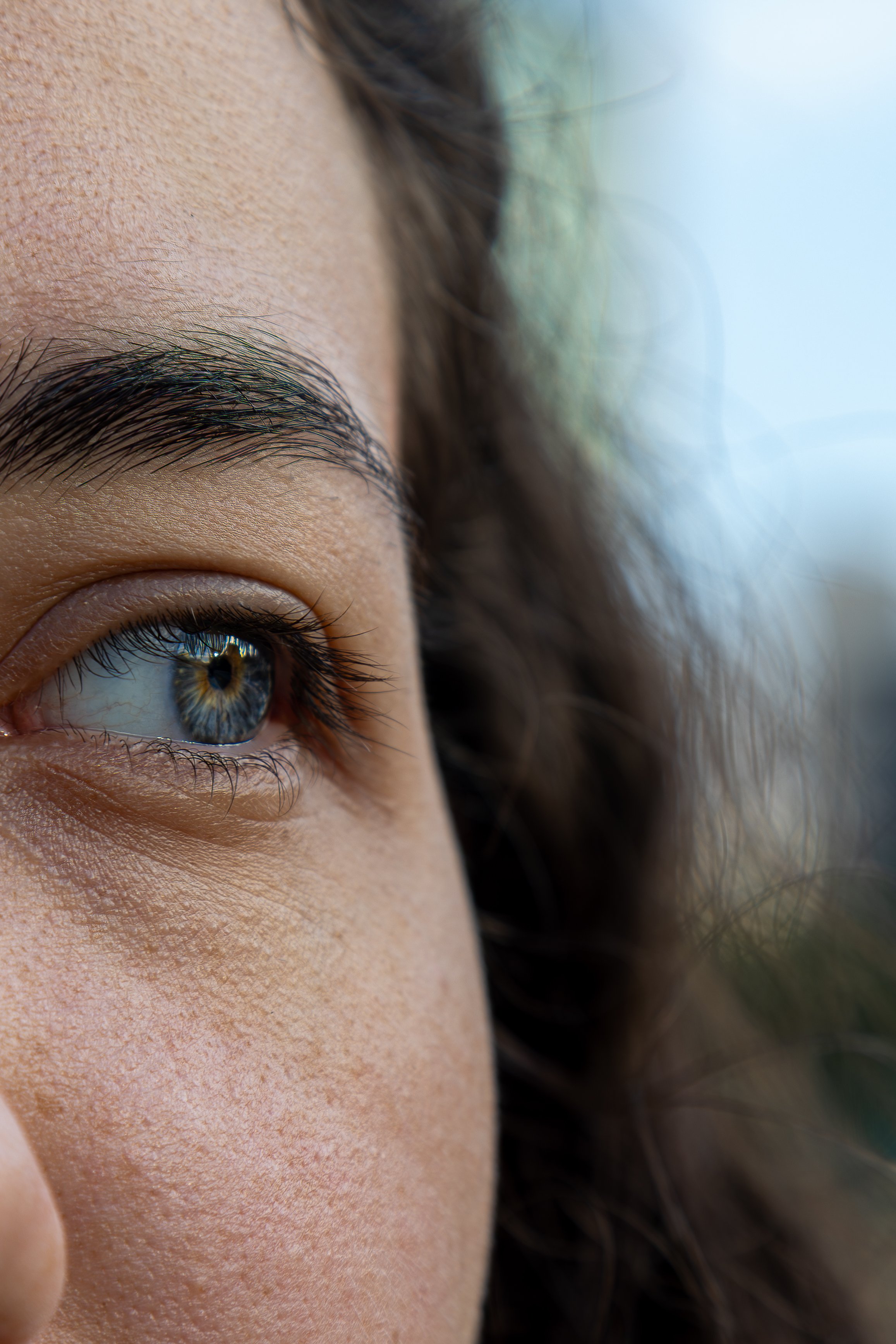 Close-up of Human Eye with Curly Hair · Free Stock Photo