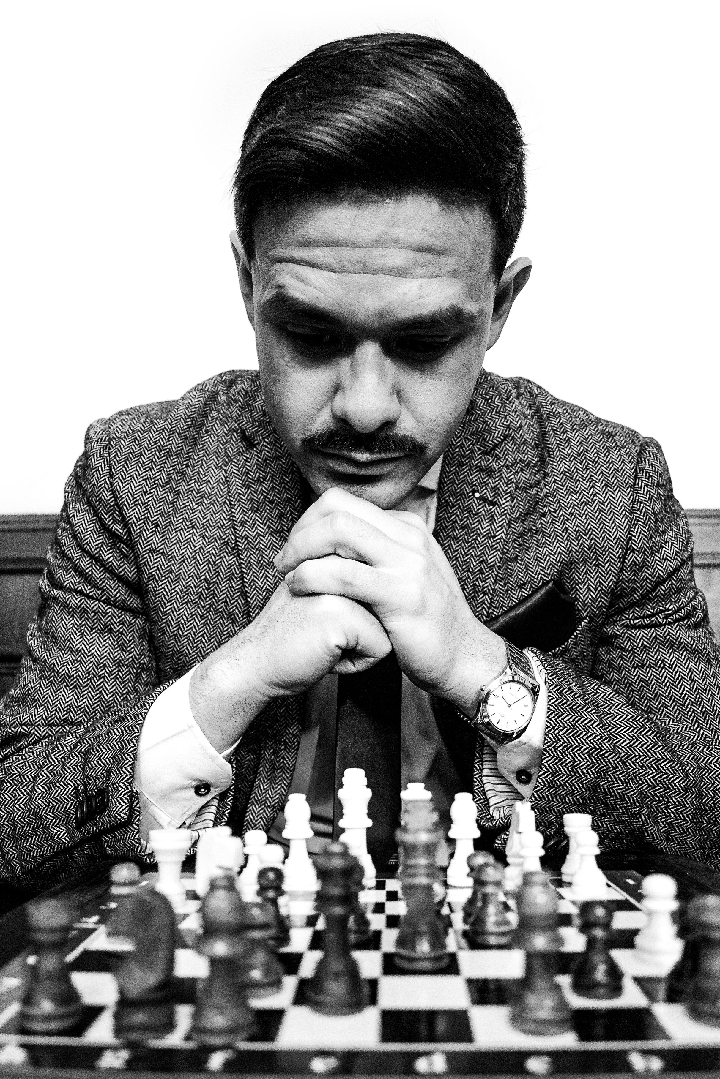 A man in a suit and tie is playing chess · Free Stock Photo
