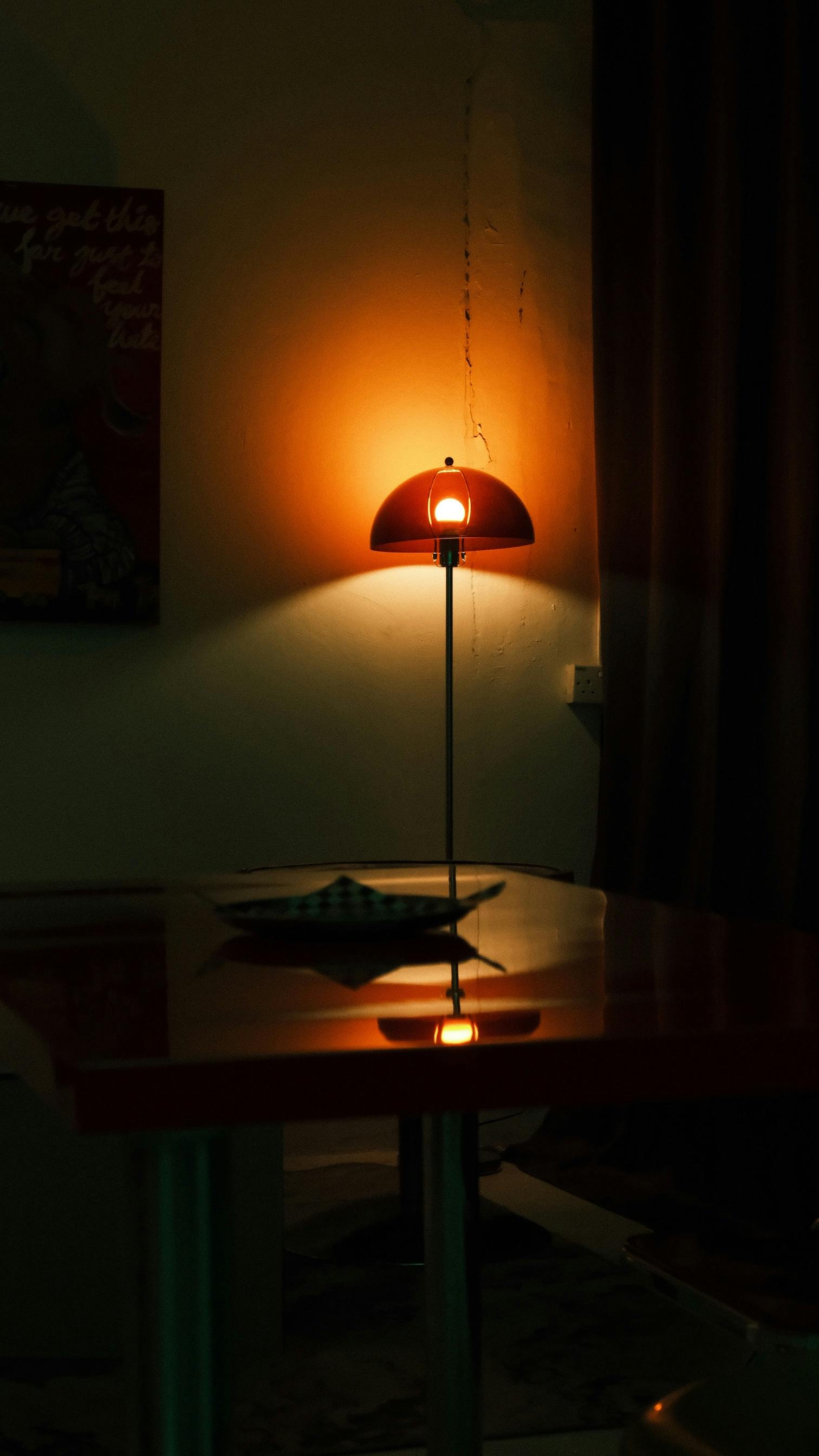 A table lamp with a small orange light on it · Free Stock Photo