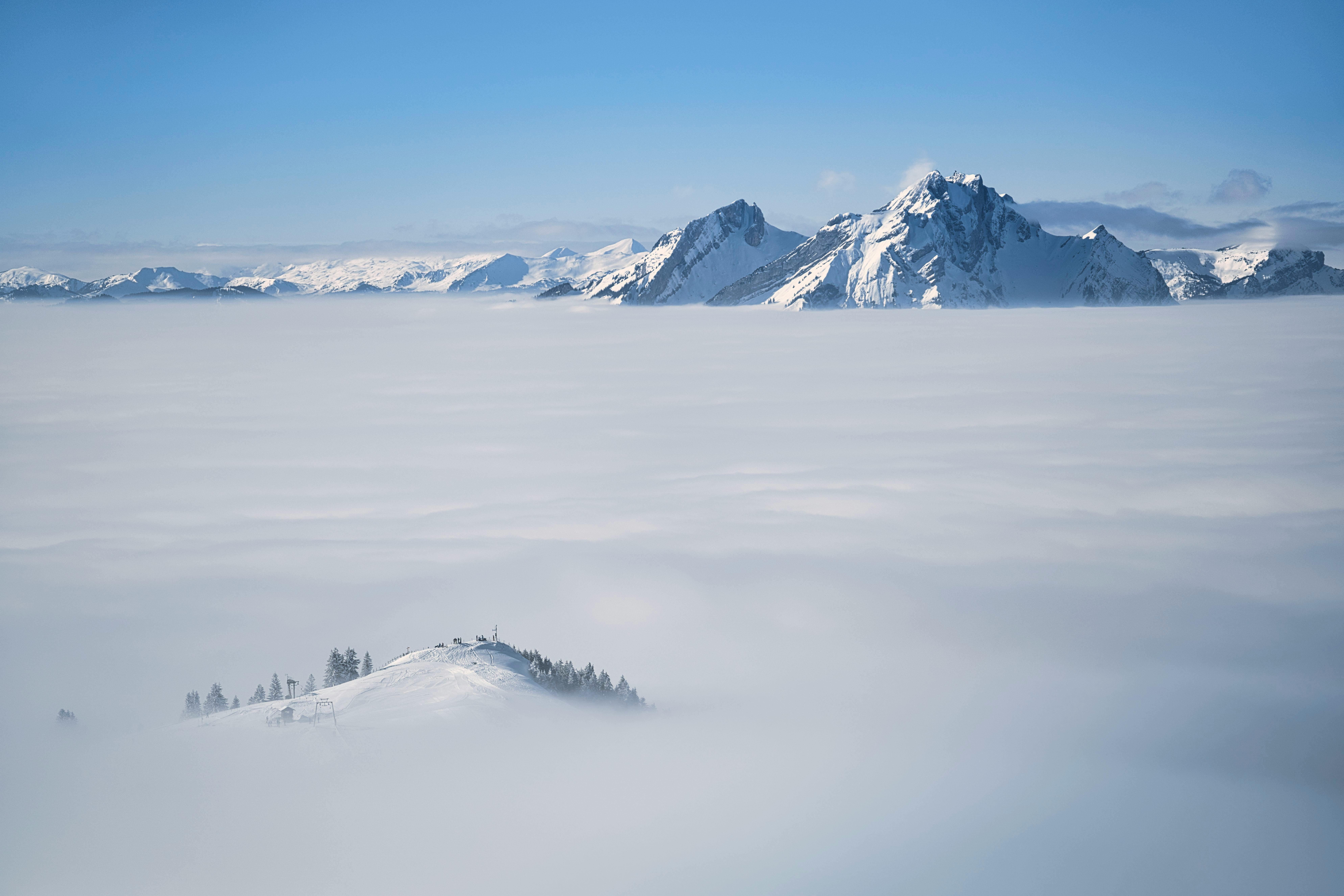 Scenic View of Snowcapped Mountain Peaks above the Clouds · Free Stock ...