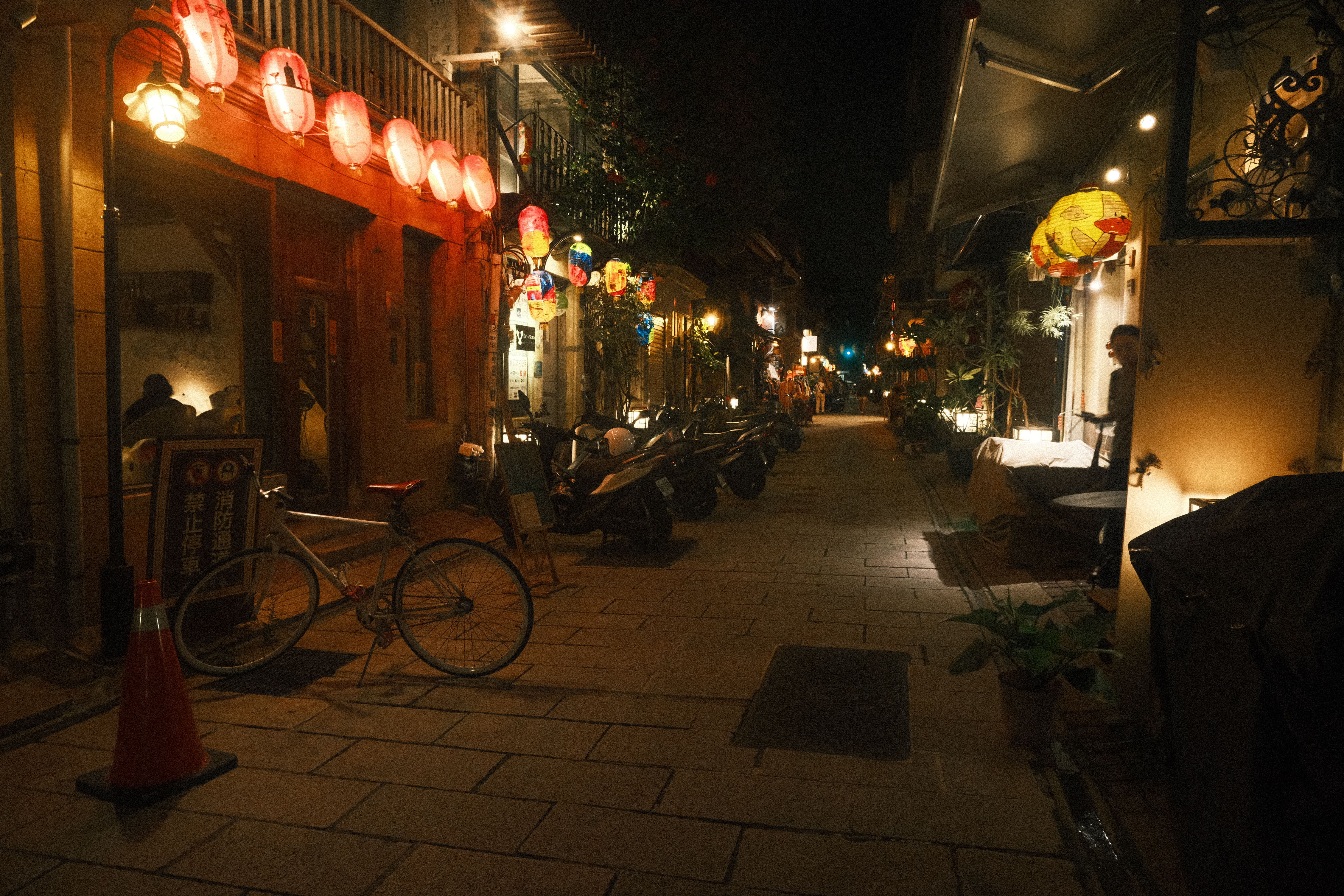 Charming Night Street with Lanterns and Bikes · Free Stock Photo