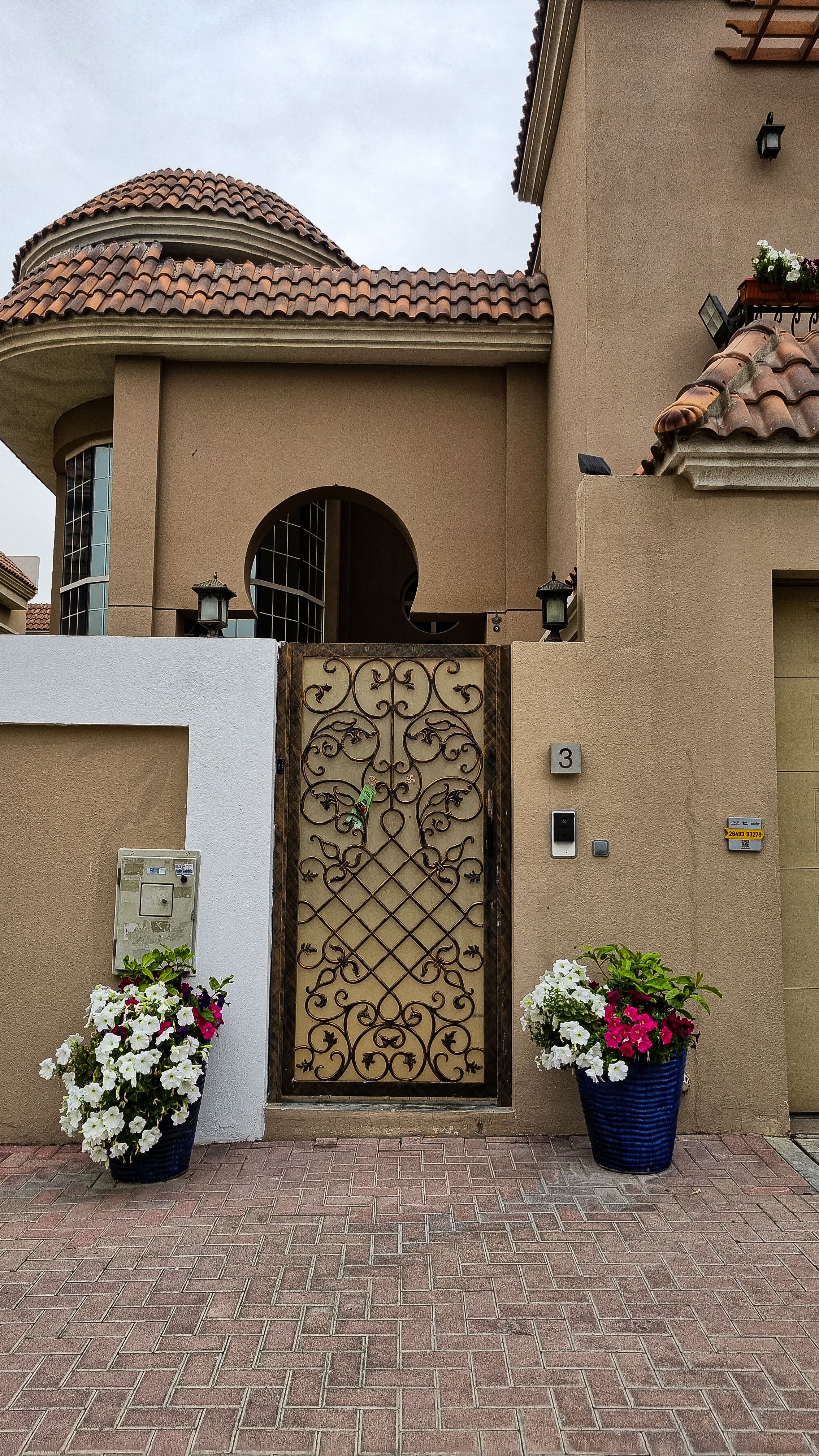 A house with a decorative gate and potted plants · Free Stock Photo