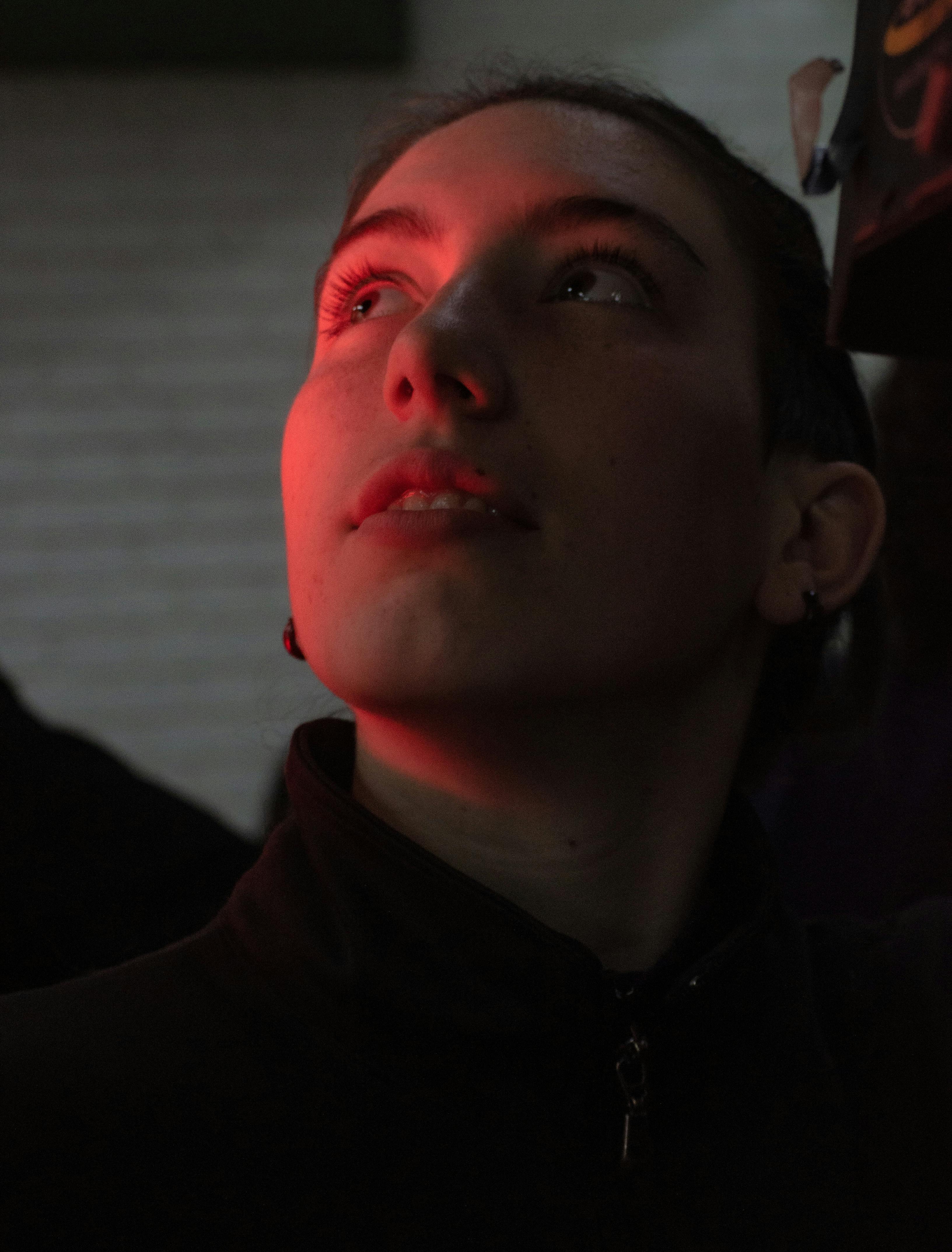 Anonymous woman with rainbow light on face · Free Stock Photo