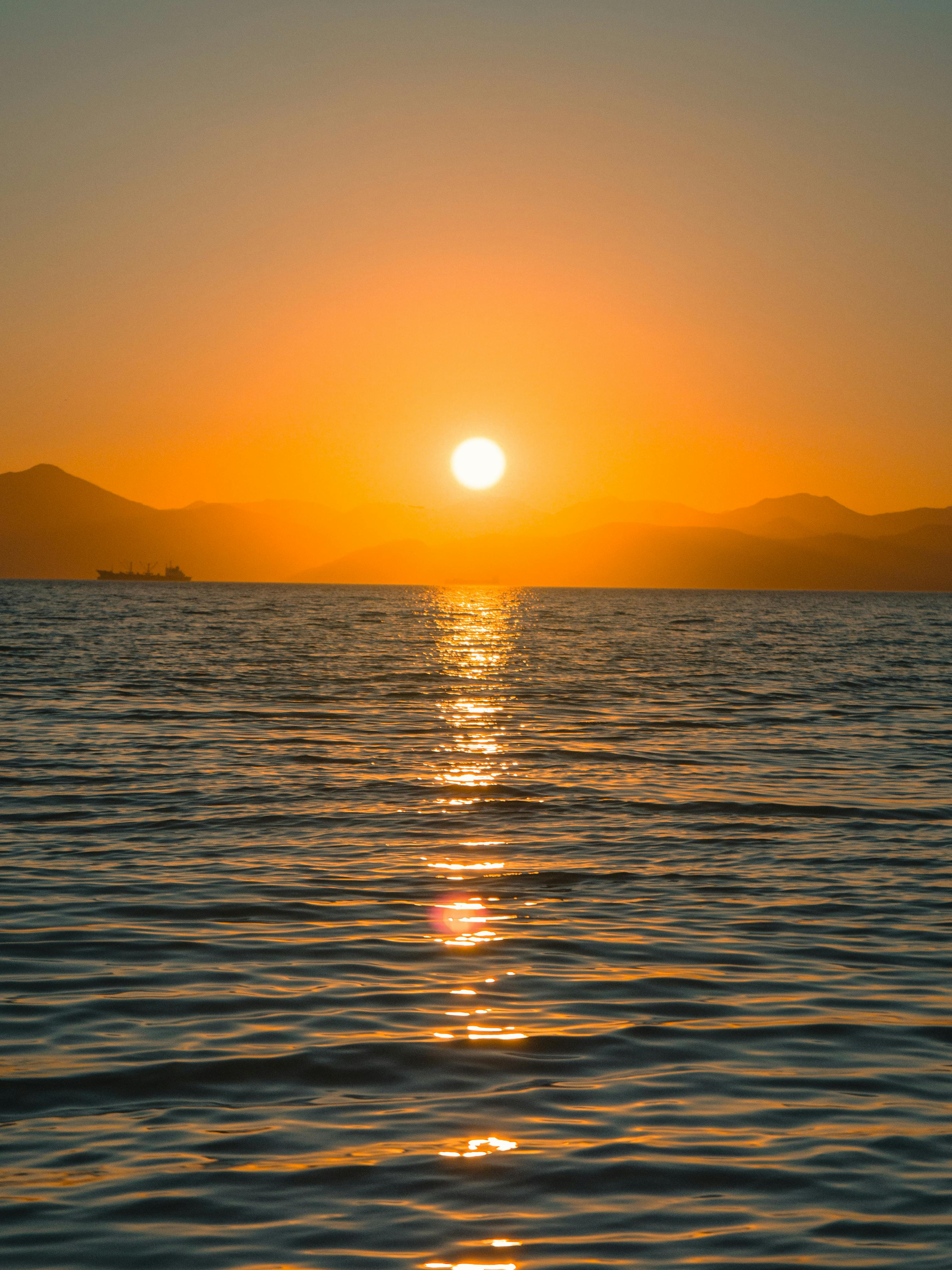 A Hand on the Water During Sunset · Free Stock Photo