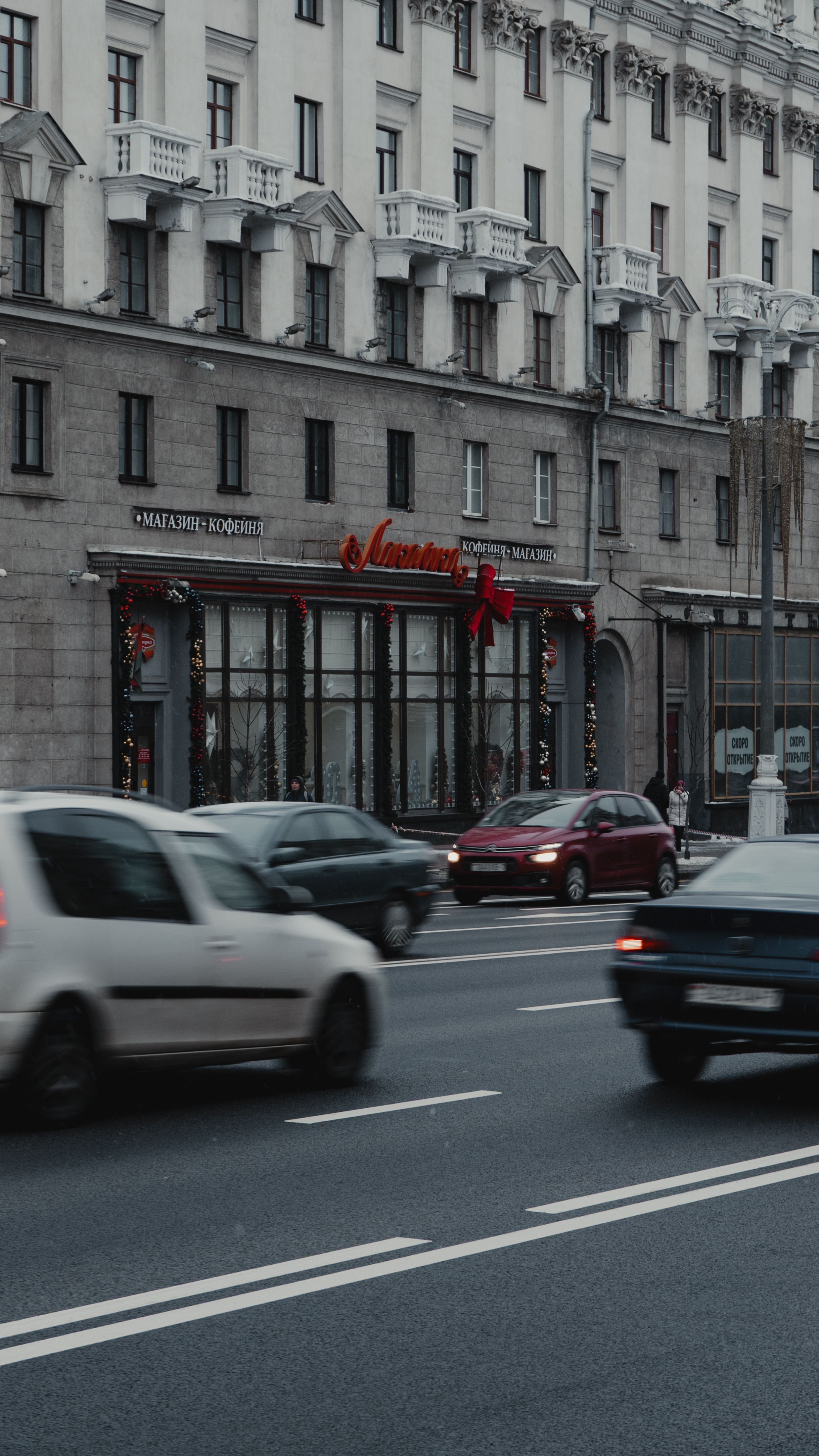 Cars driving down a street in a city · Free Stock Photo