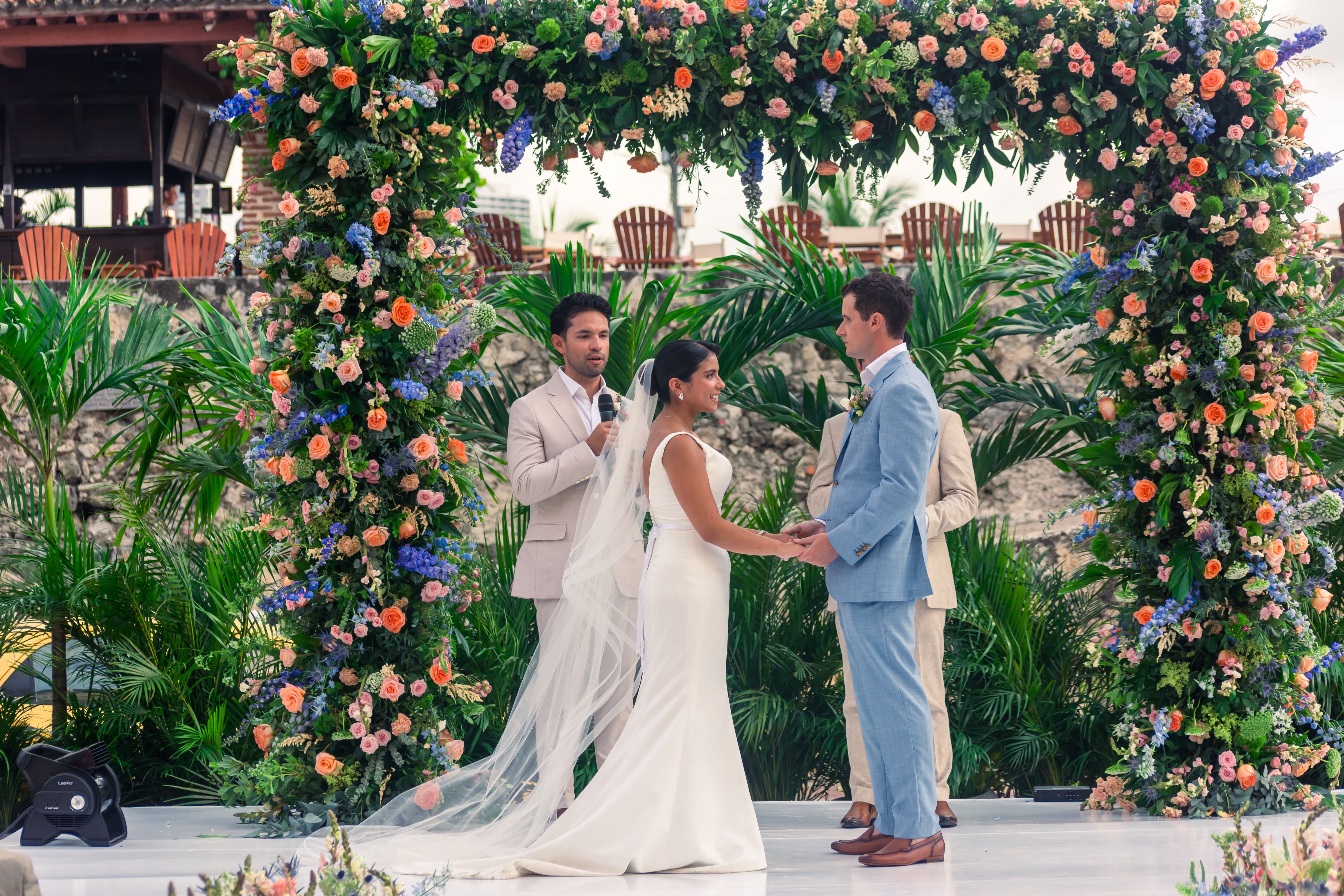 Romantic Outdoor Wedding Ceremony Under Floral Arch · Free Stock Photo