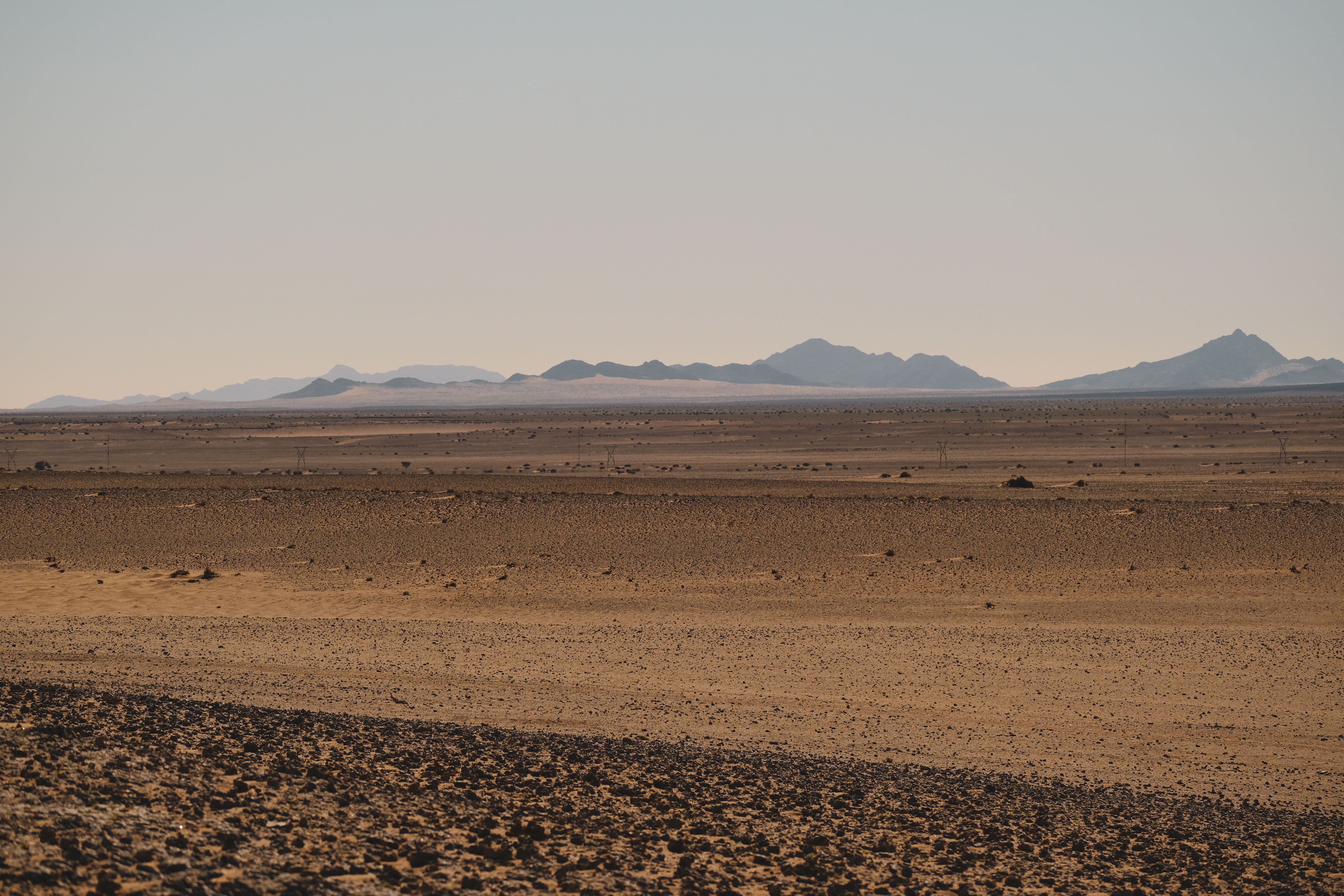A desert landscape with mountains in the distance · Free Stock Photo