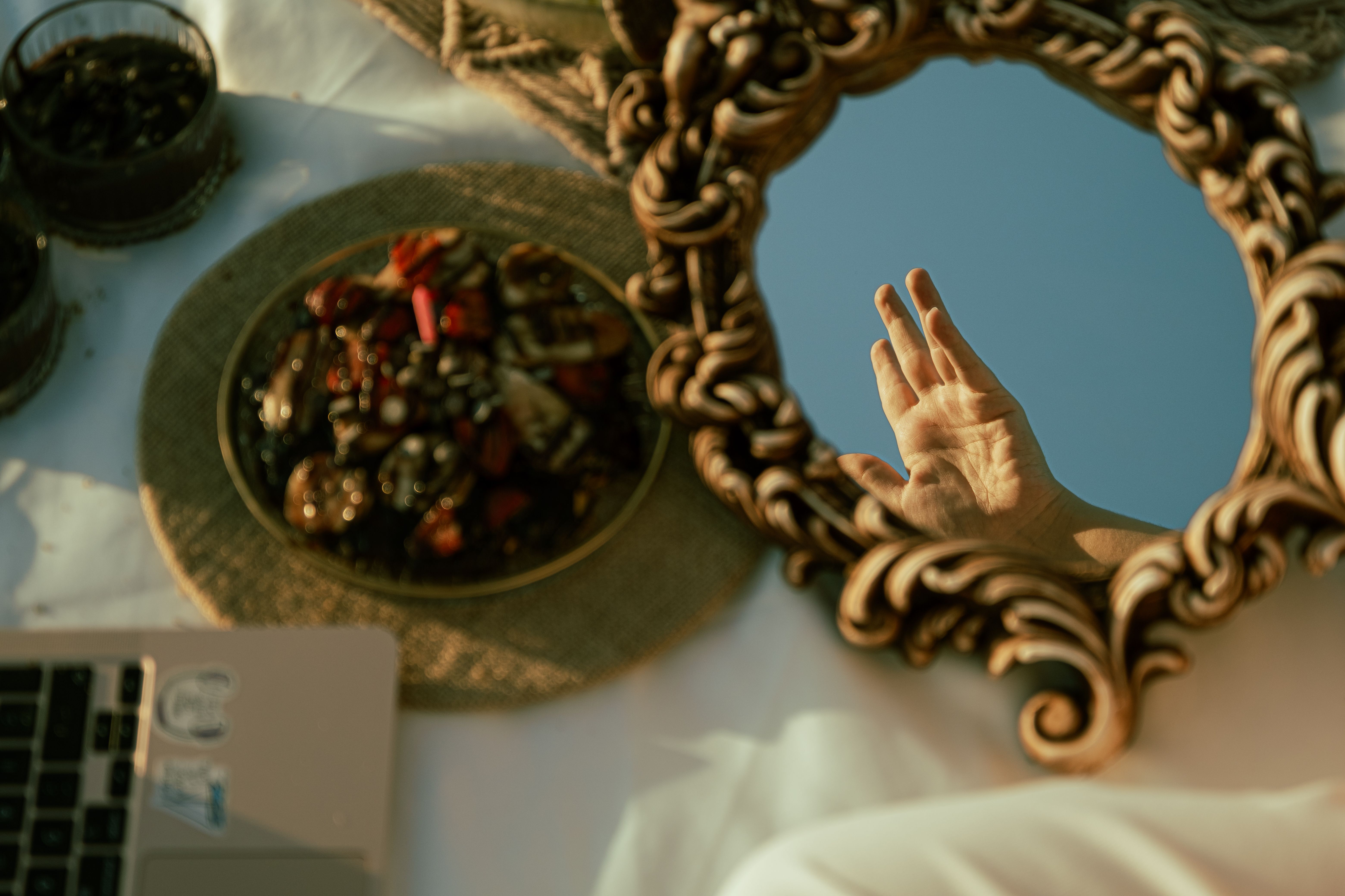 A person's hand is reflected in a mirror · Free Stock Photo