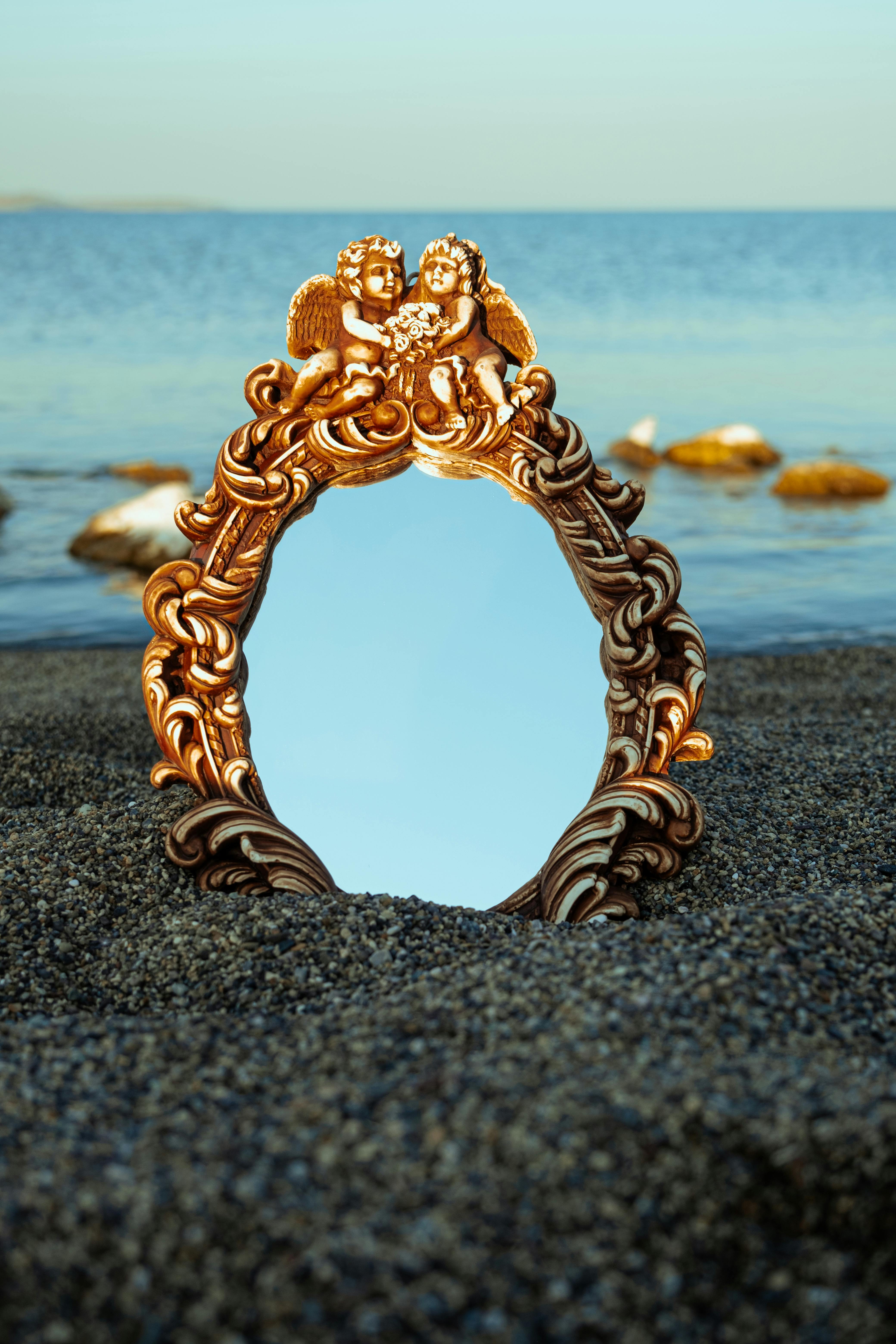 A mirror on the beach with sand and water · Free Stock Photo