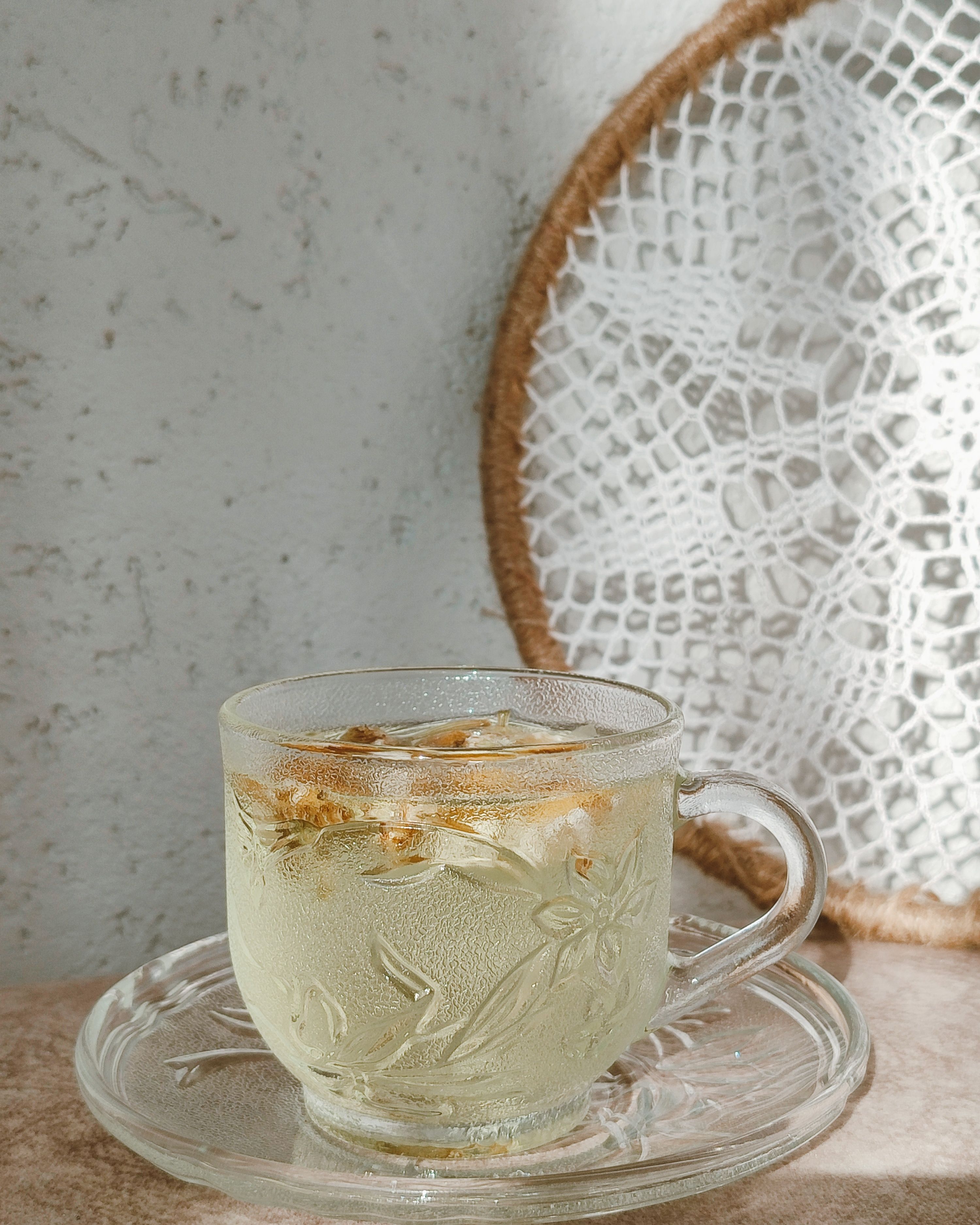 Elegant Glass Cup of Floral Tea with Lace Decor · Free Stock Photo