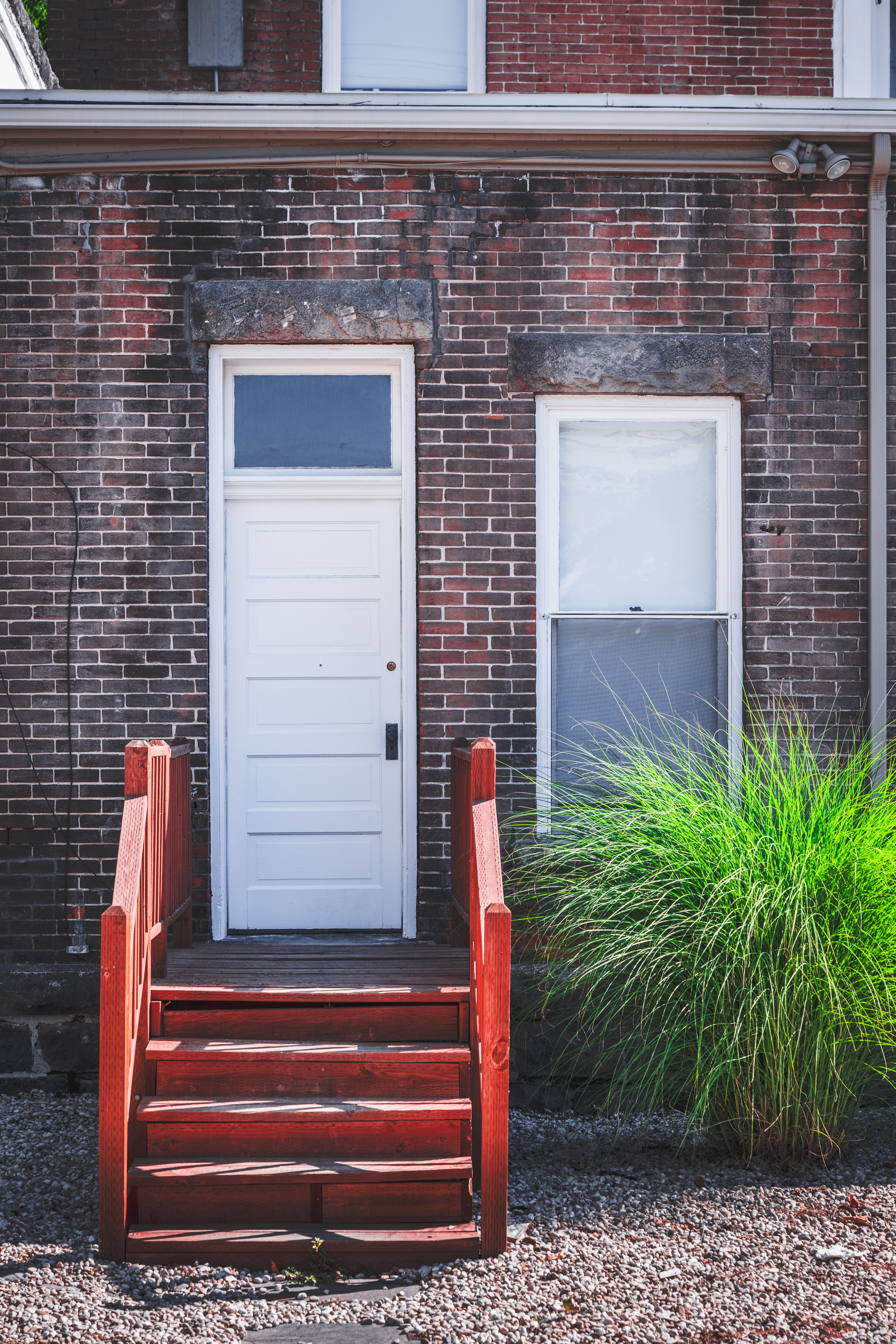 A red door and steps leading to a house · Free Stock Photo