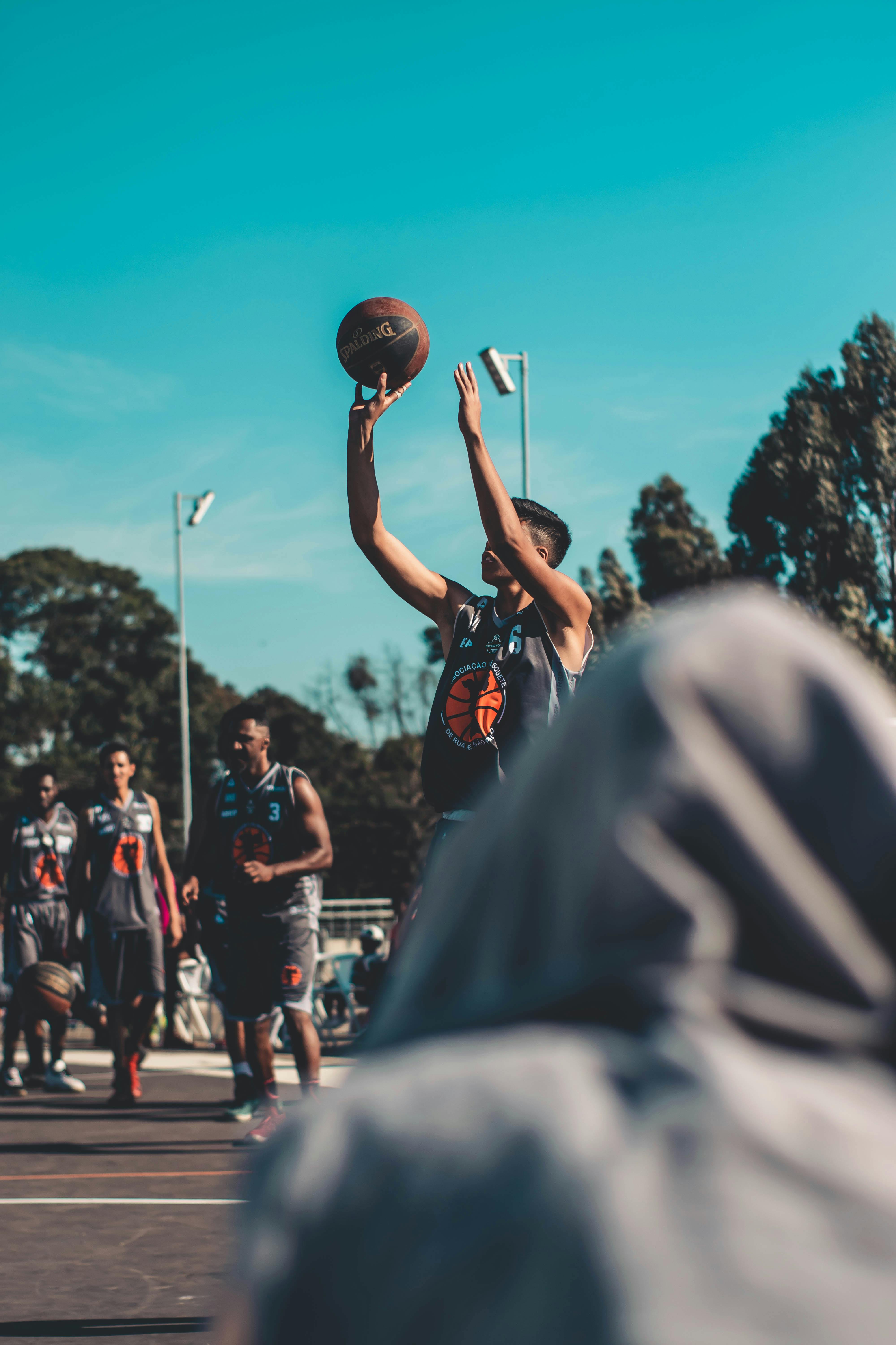 Shallow Focus Photo of Man Shooting The Ball · Free Stock Photo