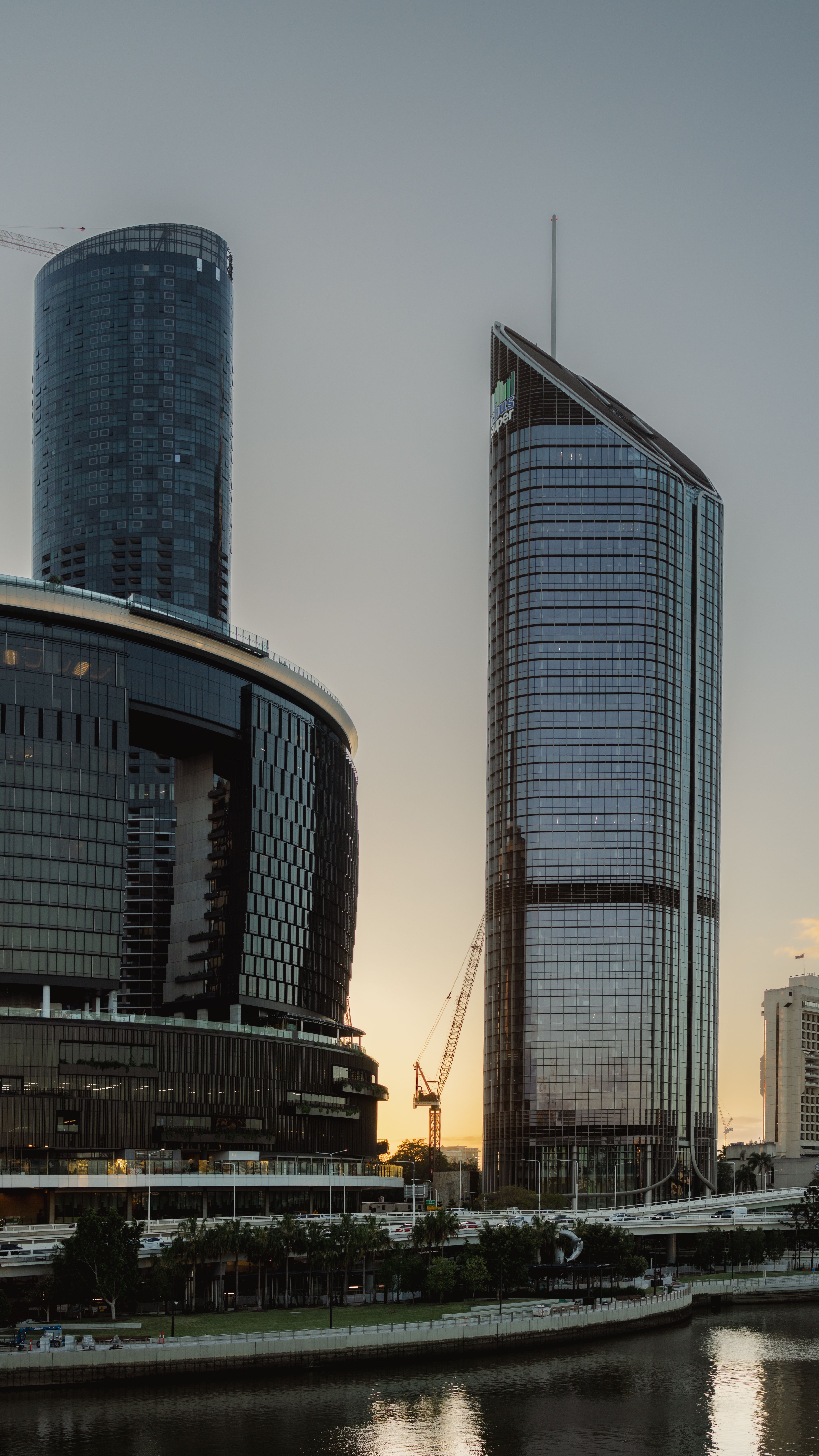 A view of two tall buildings next to a river · Free Stock Photo