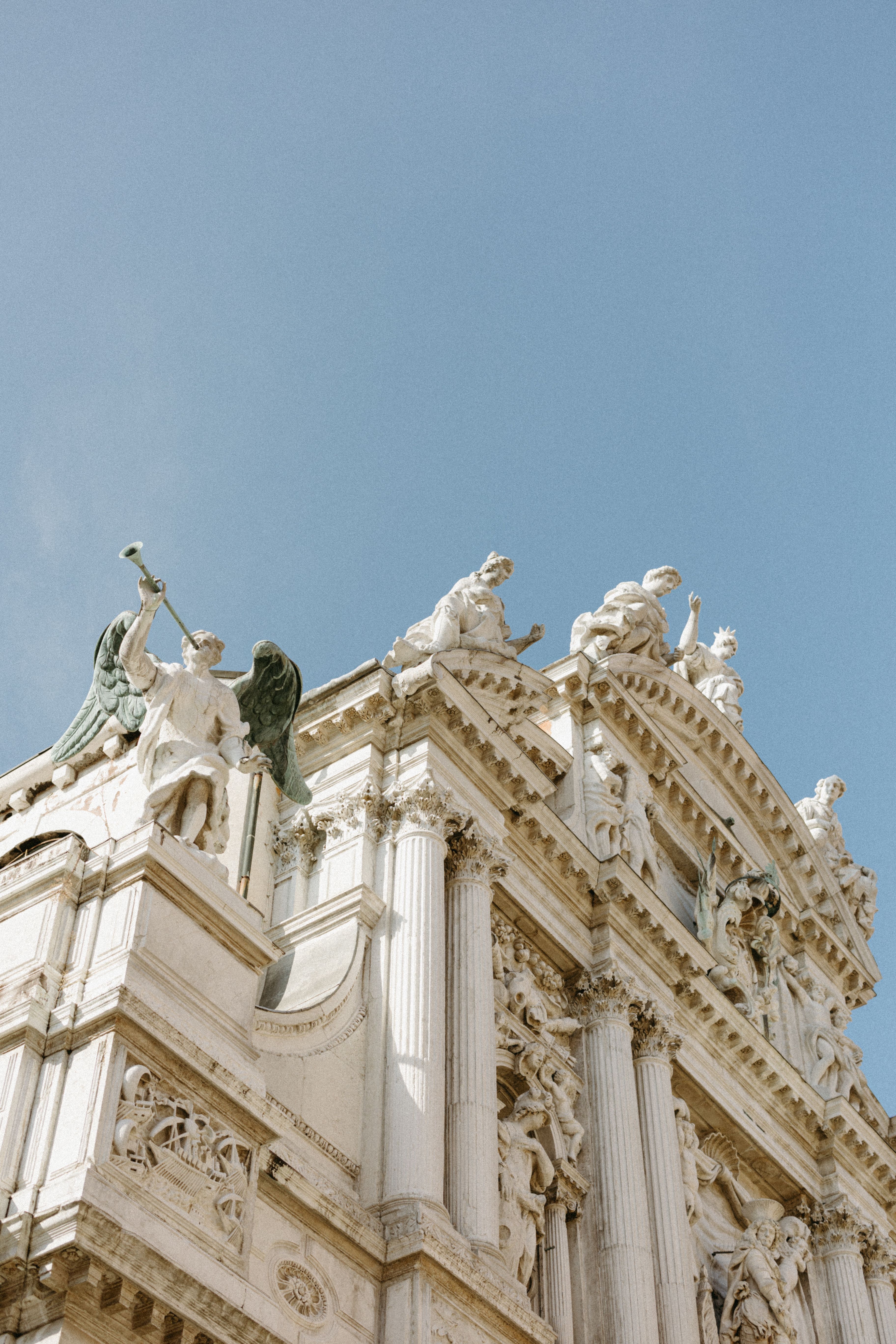 A close up of a building with statues on it · Free Stock Photo