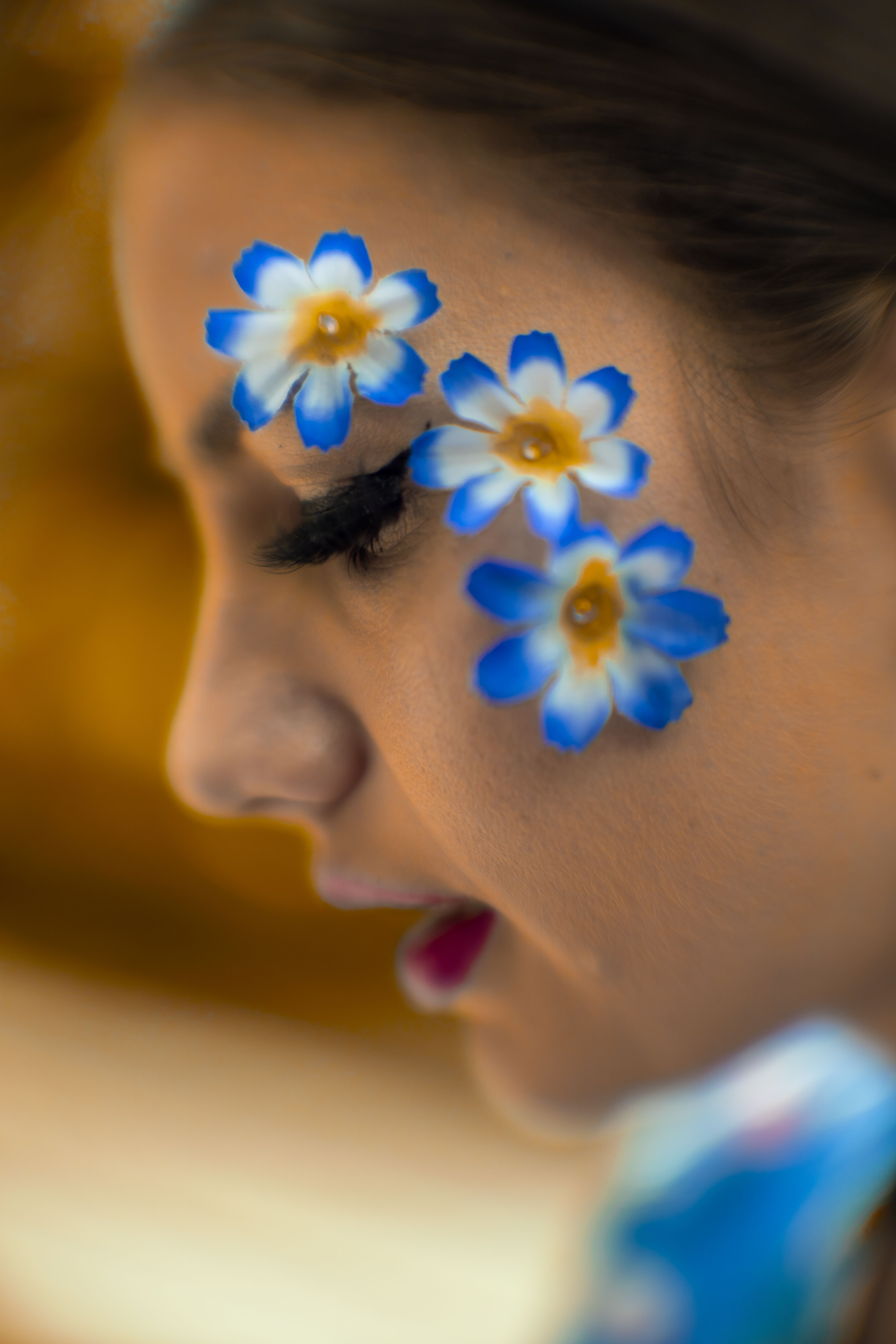 A woman with blue flowers on her face · Free Stock Photo